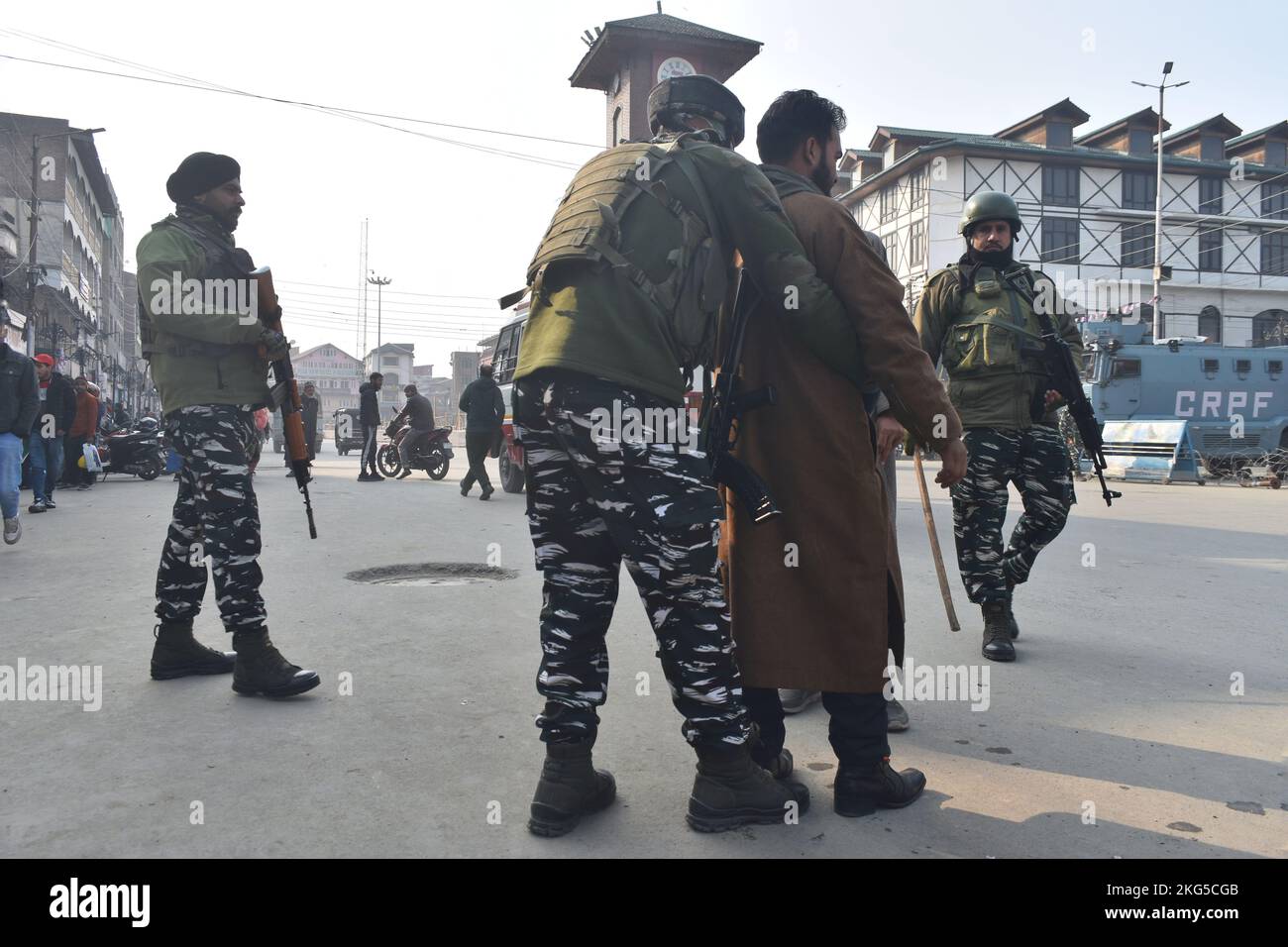 Indian paramilitary forces frisk a boy during a surprise search ...