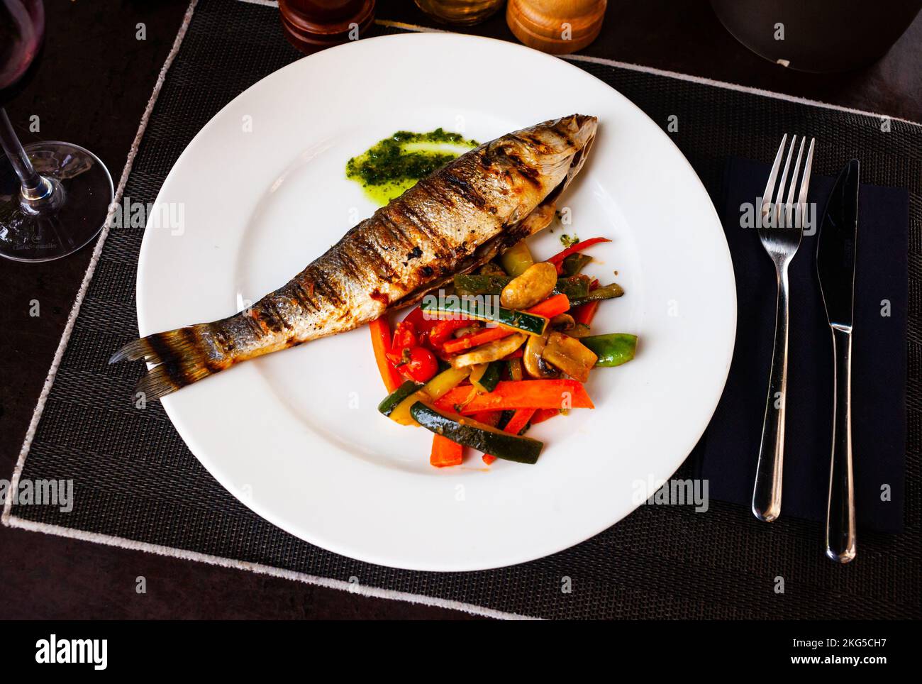 Delicious fish dish - baked sea bass with stewed vegetables Stock Photo ...