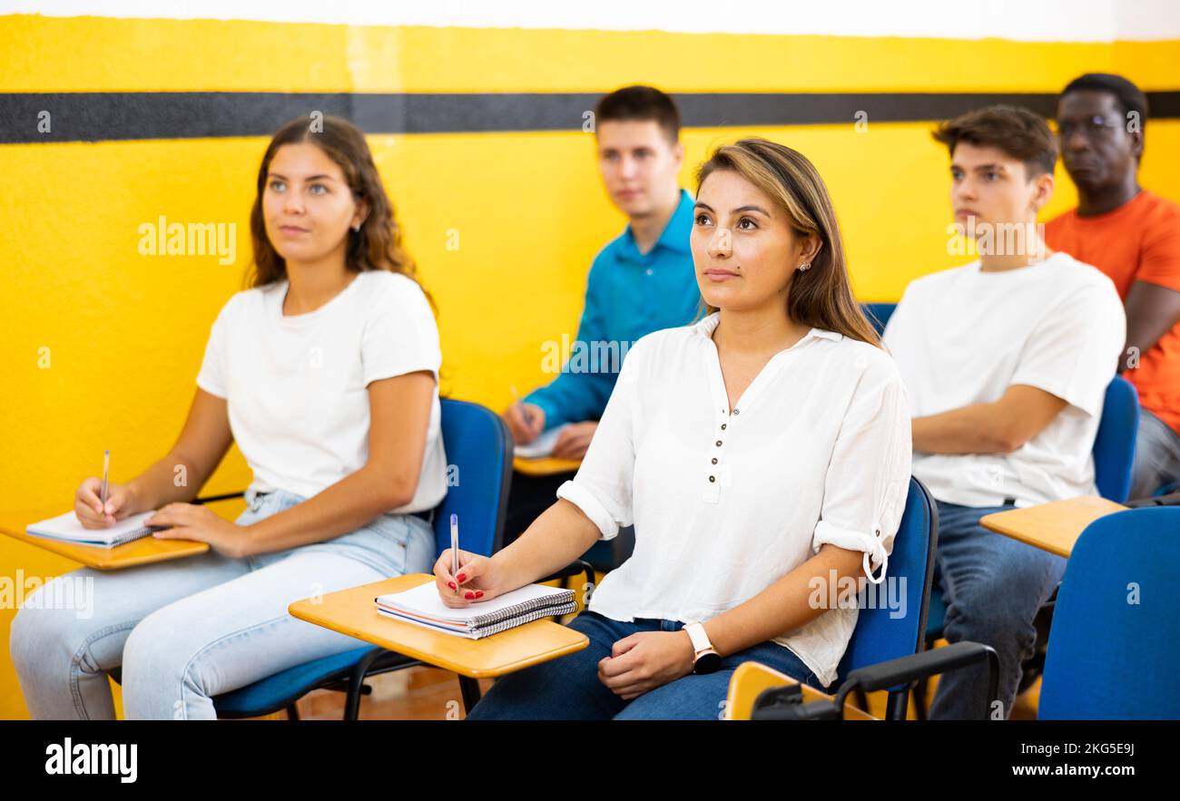 Women and men attending lecture in taxi training school Stock Photo - Alamy