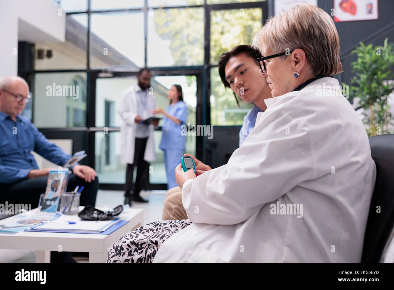 Elderly medic measuring glucose and insulin level with glucometer while ...