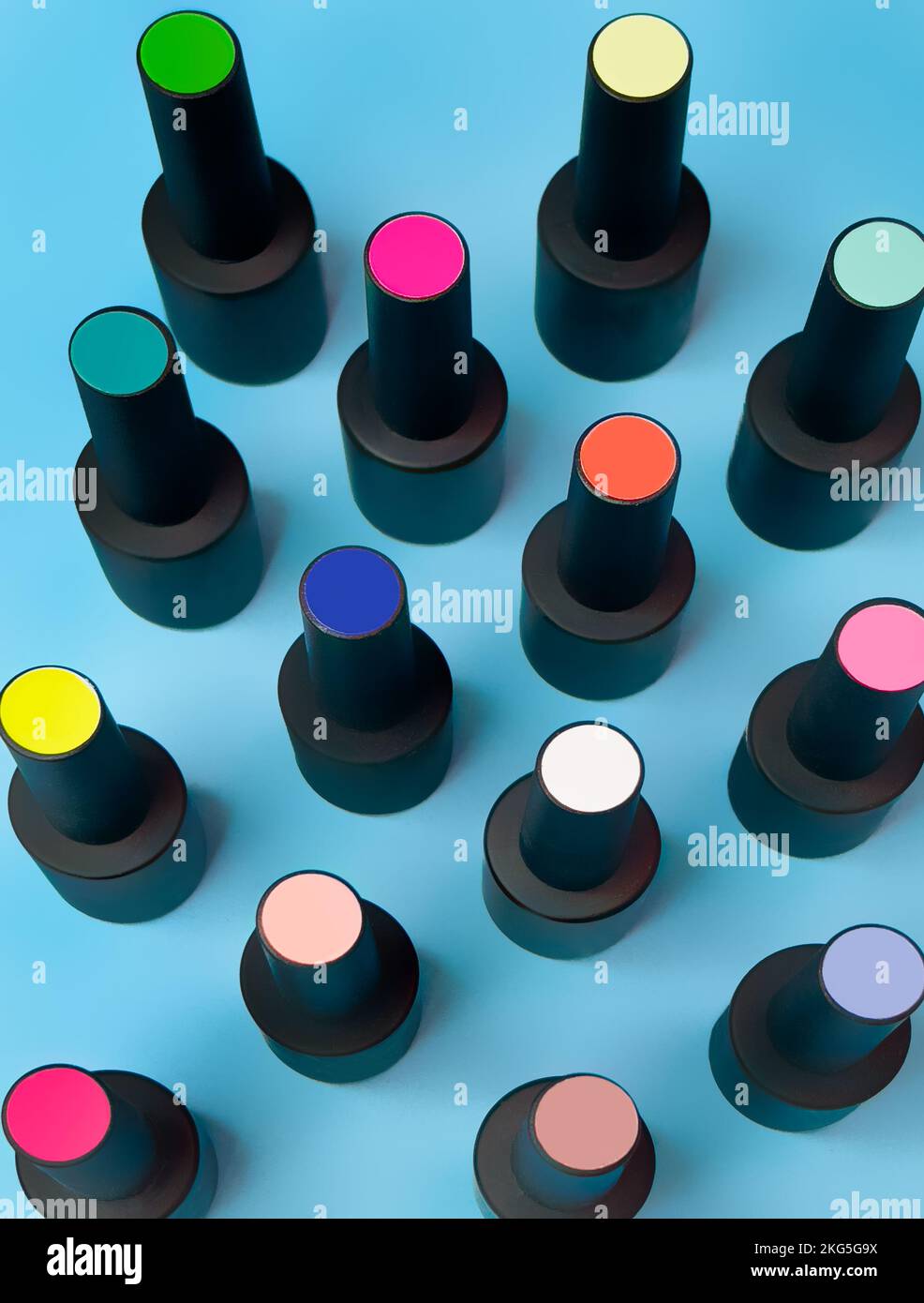 Black bottles of nail polish on a blue background Stock Photo - Alamy