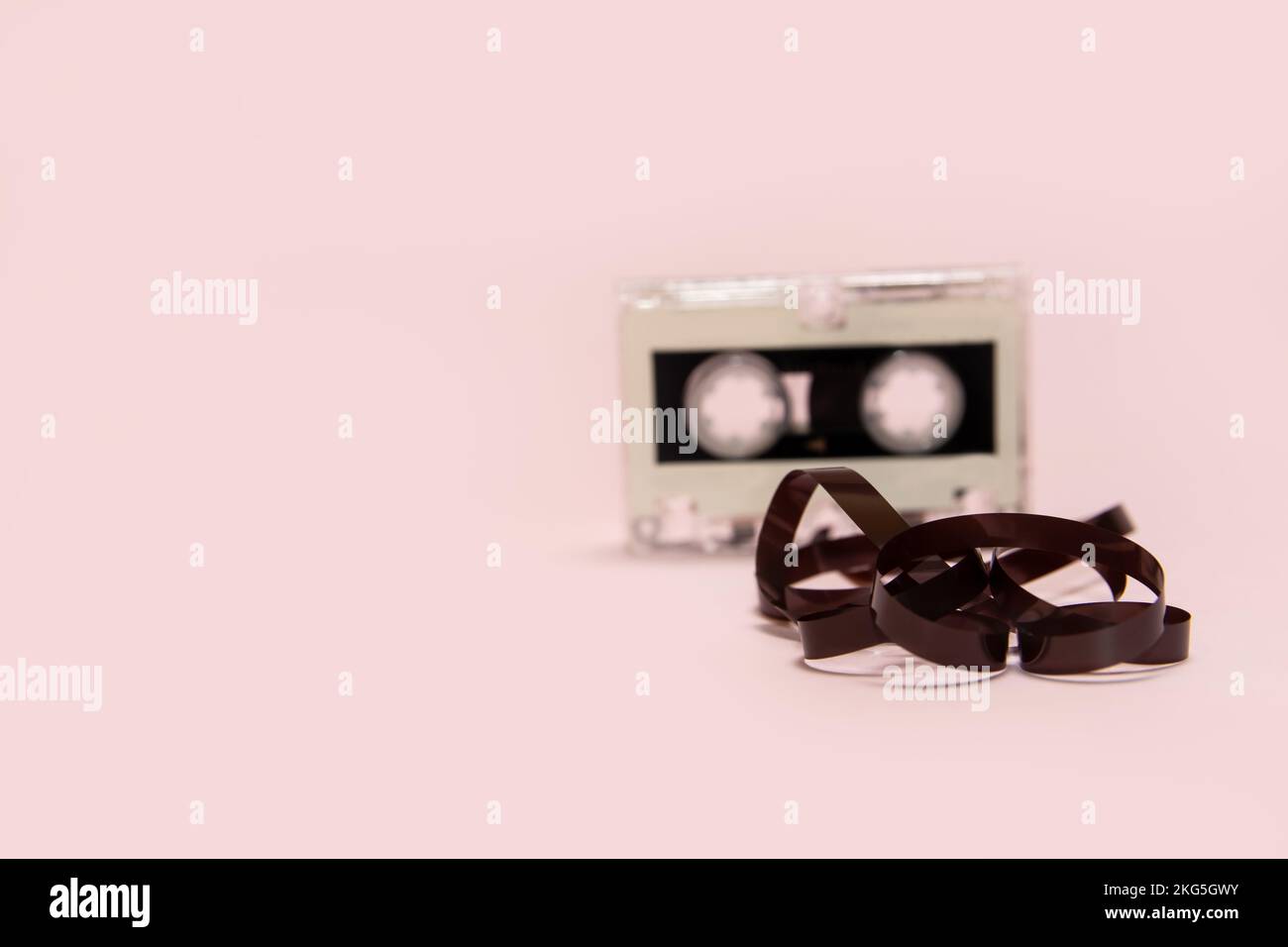 Audio cassette with tape pulled out on a pink background Stock Photo ...
