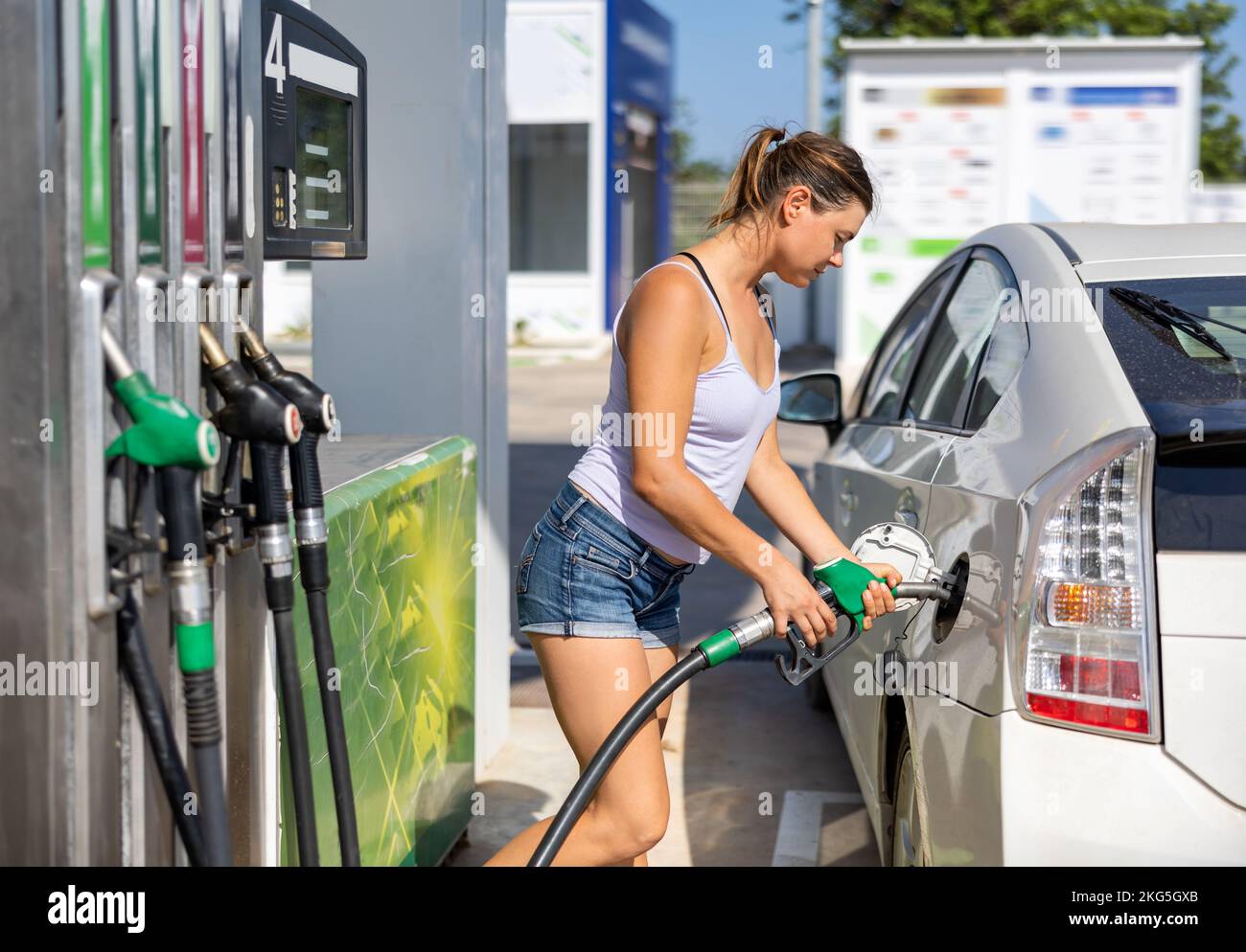 Woman filling up tank of her car with gasoline Stock Photo - Alamy