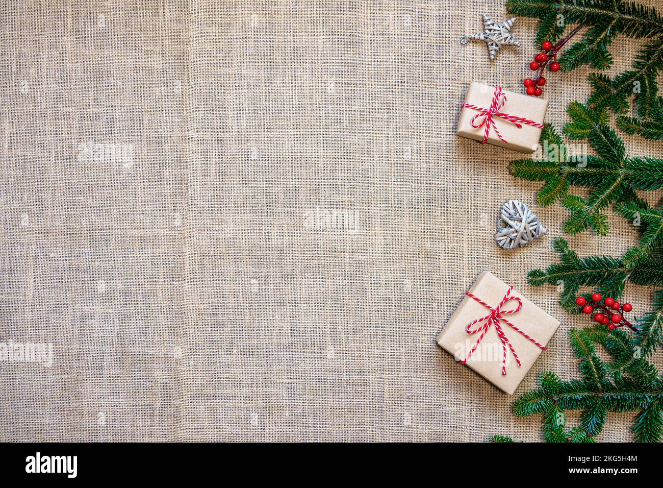 Flat Christmas frame made of spruce branches, gift box and ornaments ...