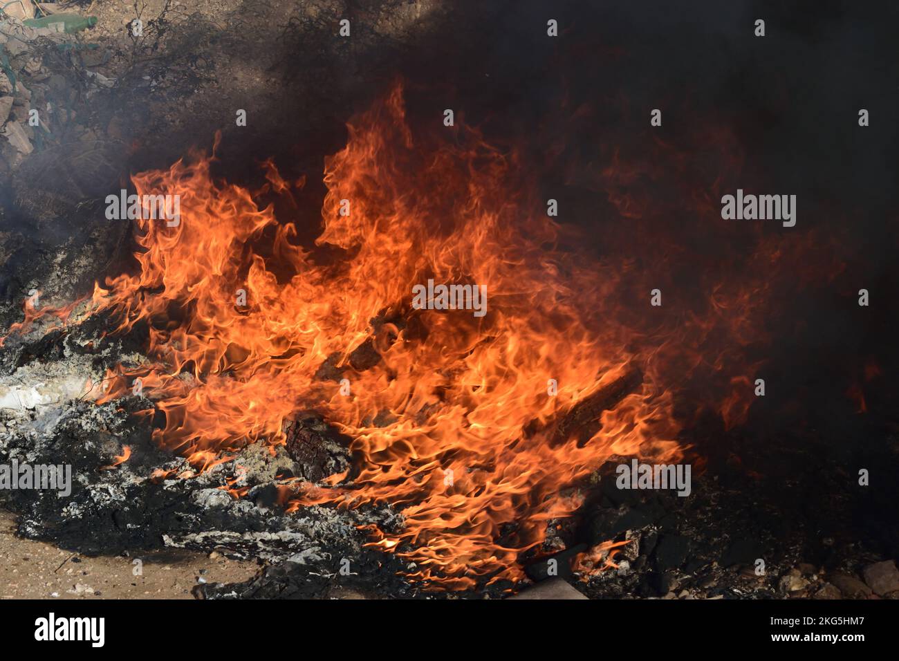 View of fire with black smoke due to burning garbage Stock Photo - Alamy
