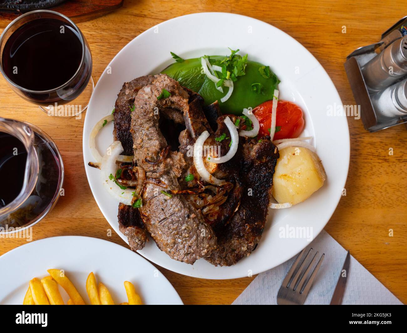 Grilled beef chop dinner served with vegetable garnish Stock Photo - Alamy