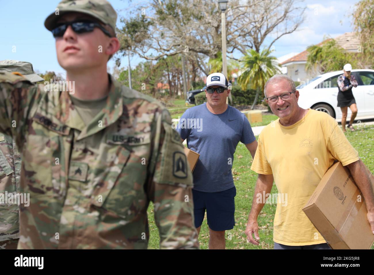 Soldiers with the 1-265th Air Defense Artillery (ADA), deliver aid to ...