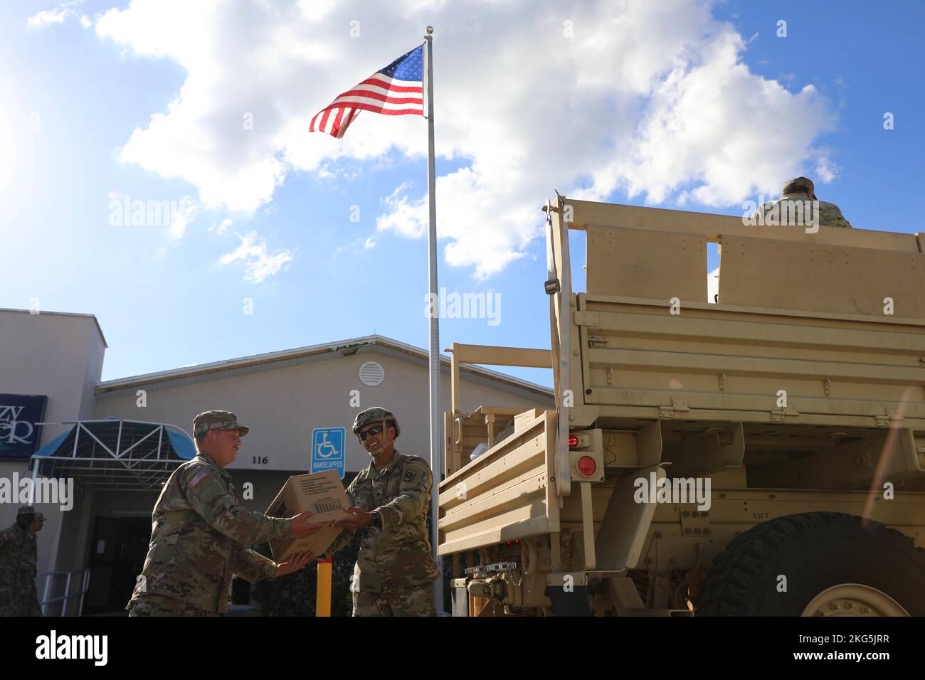 Soldiers with the 1-265th Air Defense Artillery (ADA), deliver aid to ...