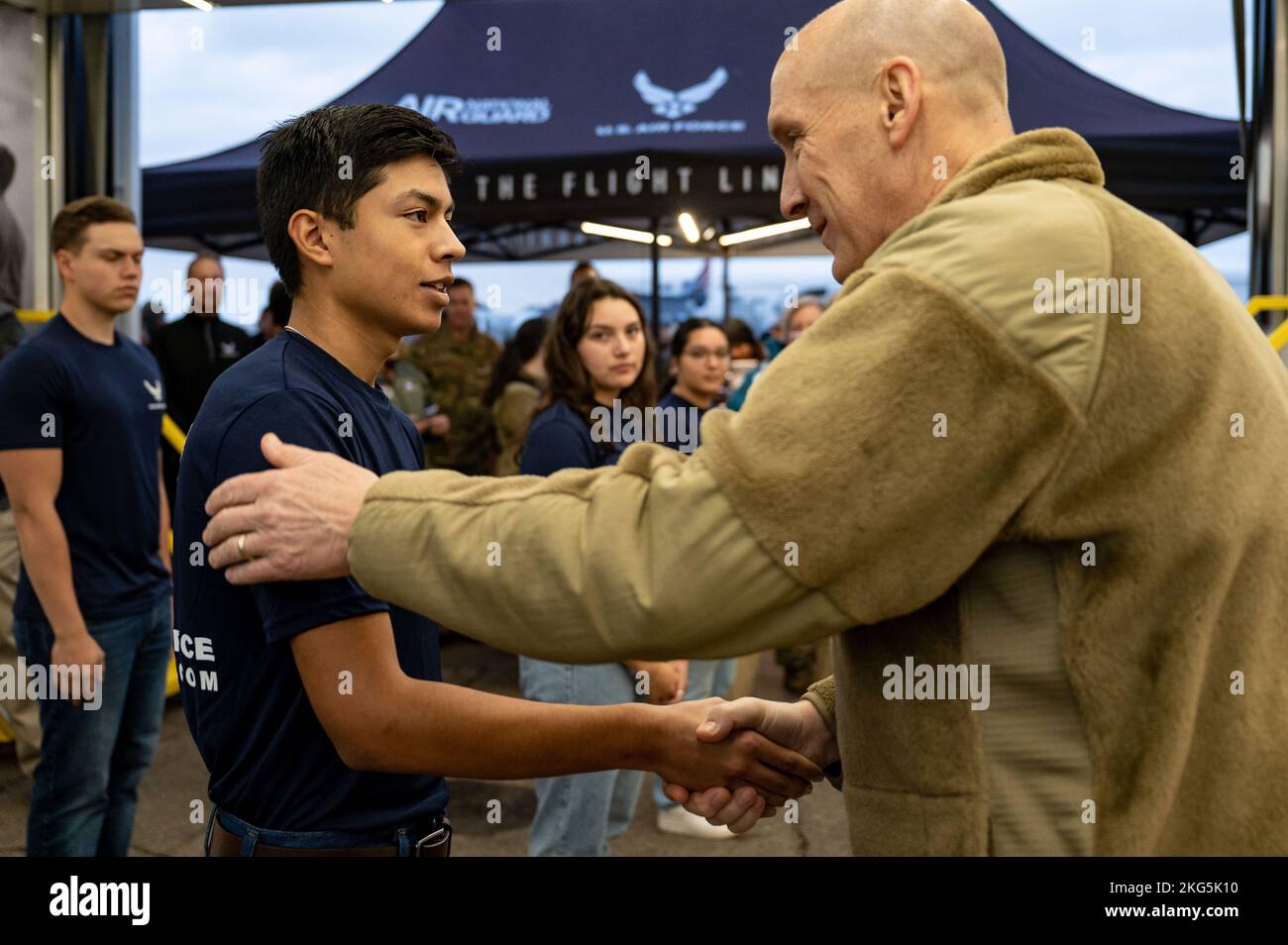 Air Force Vice Chief of Staff Gen. David W. Allvin shakes the hand of a ...