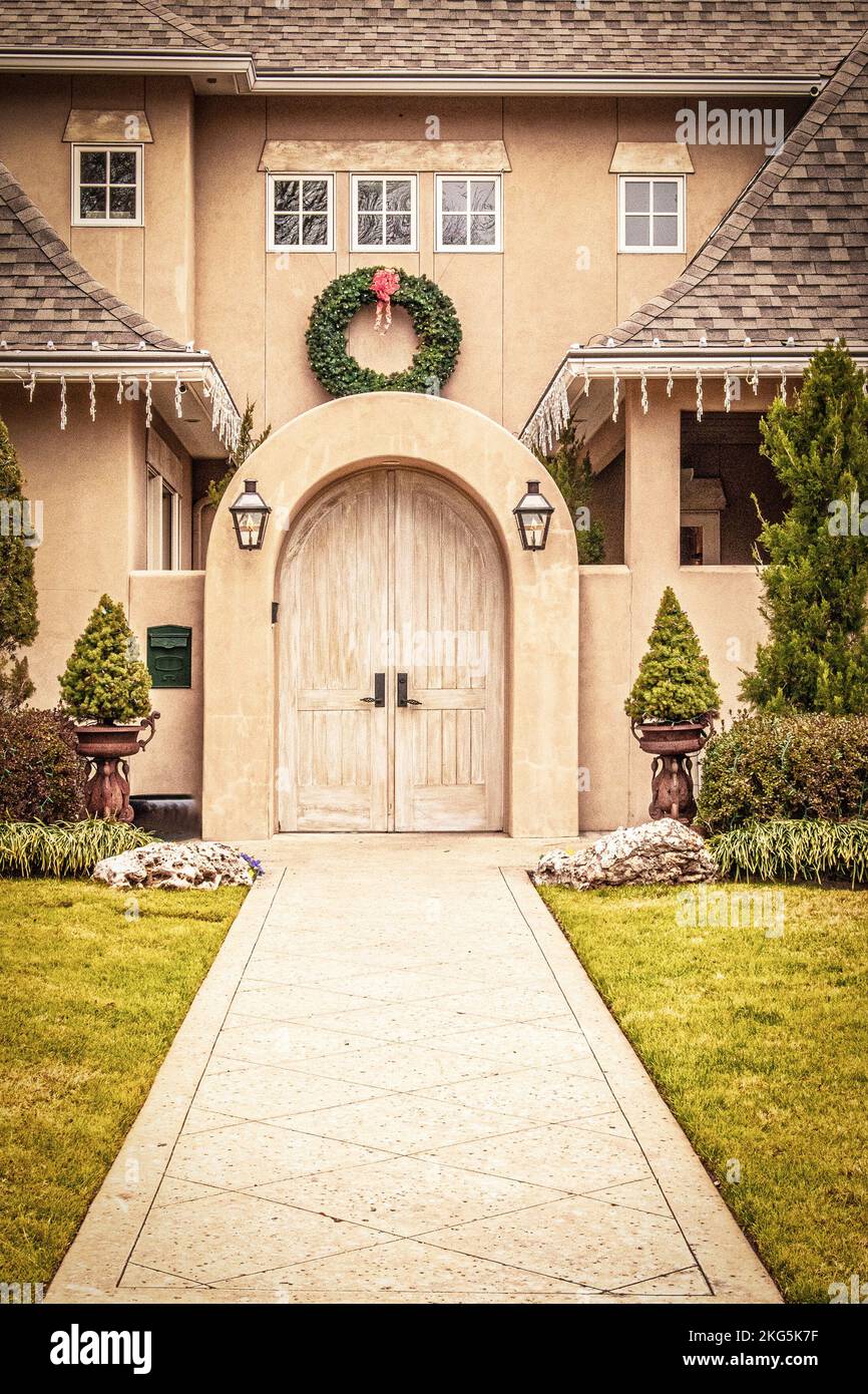 Sidewalk leading to Arched door to upscale modern stucco home with ...