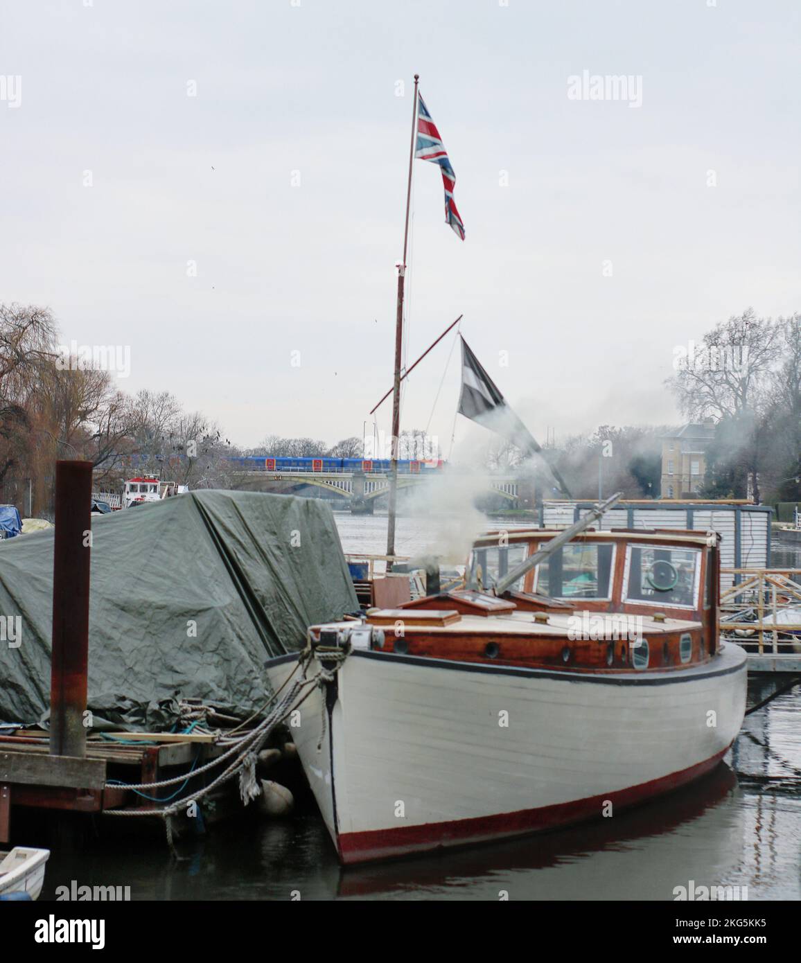 A boat with the British flag docked on the port against misty sky Stock ...
