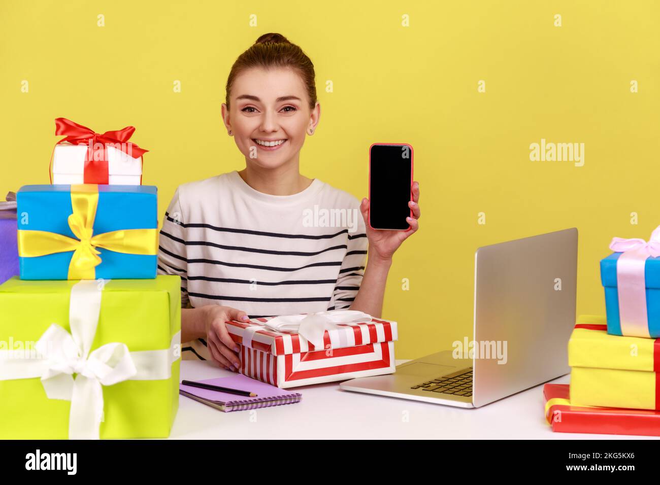 Happy woman office manager sitting at workplace, holding gift box and ...
