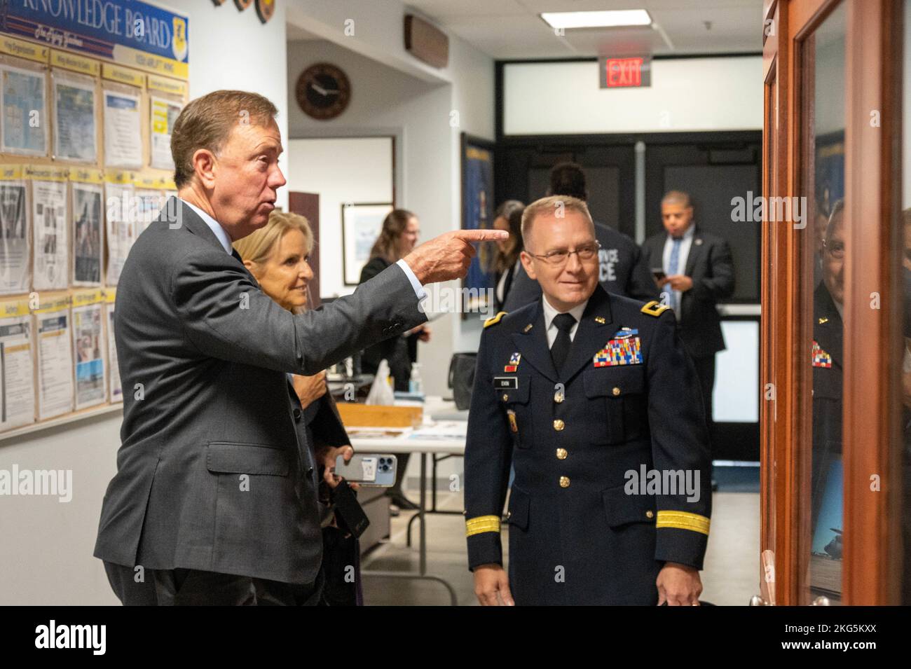 Governor Ned Lamont, standing beside his wife Annie Lamont, asks ...