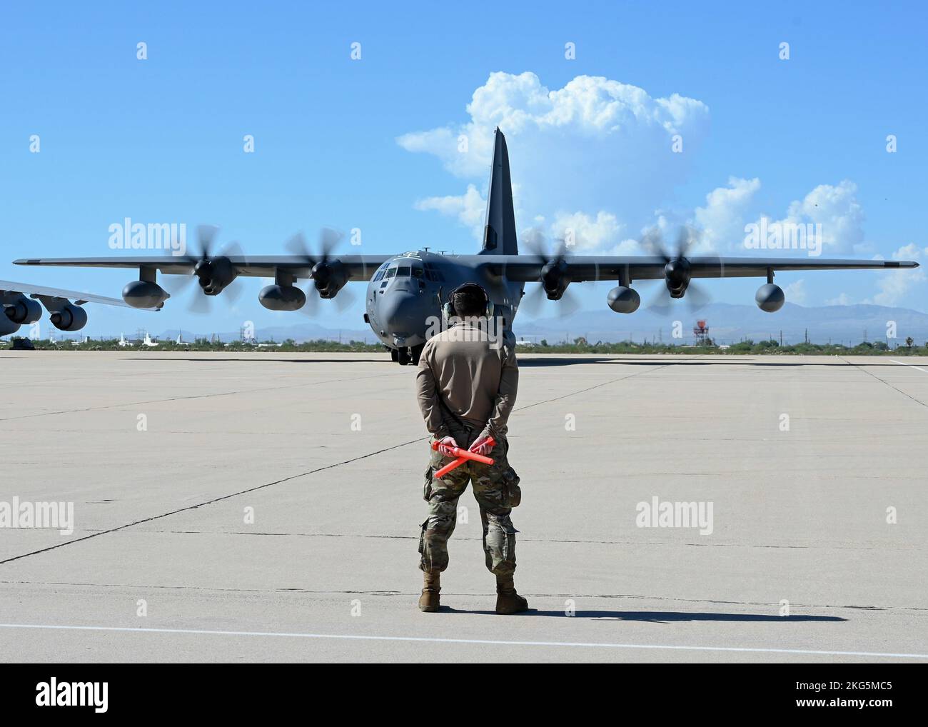 A U.S. Air Force Airman waits to marshall an HC-130J Combat King II ...
