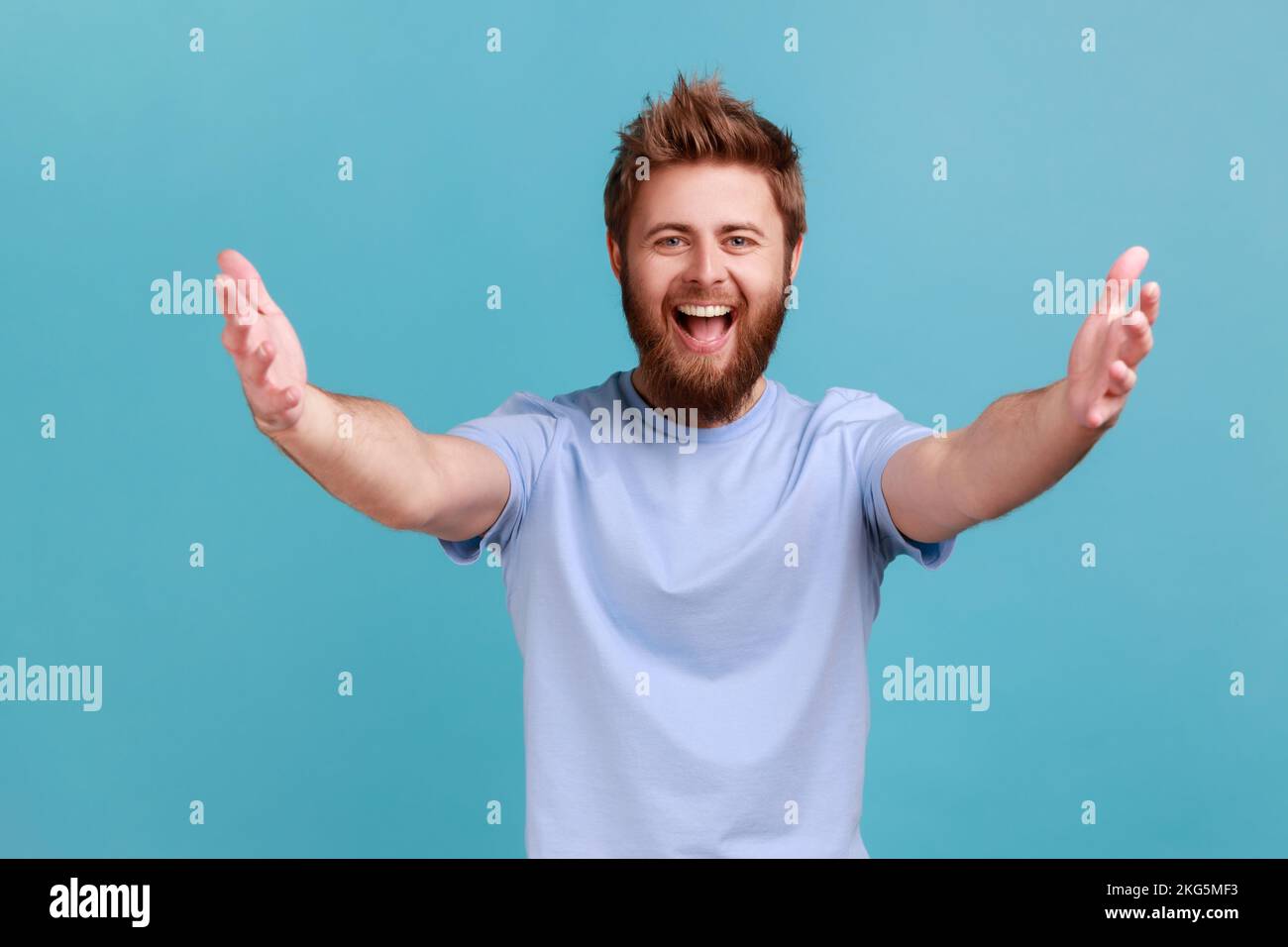 Free hugs, come into my arms. Portrait of happy bearded man stretching ...