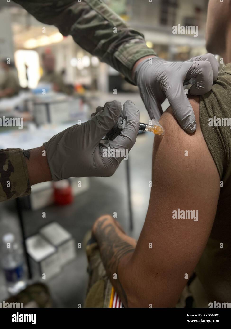 A Soldier assigned to the 1st Armored Division receives a flu shot ...
