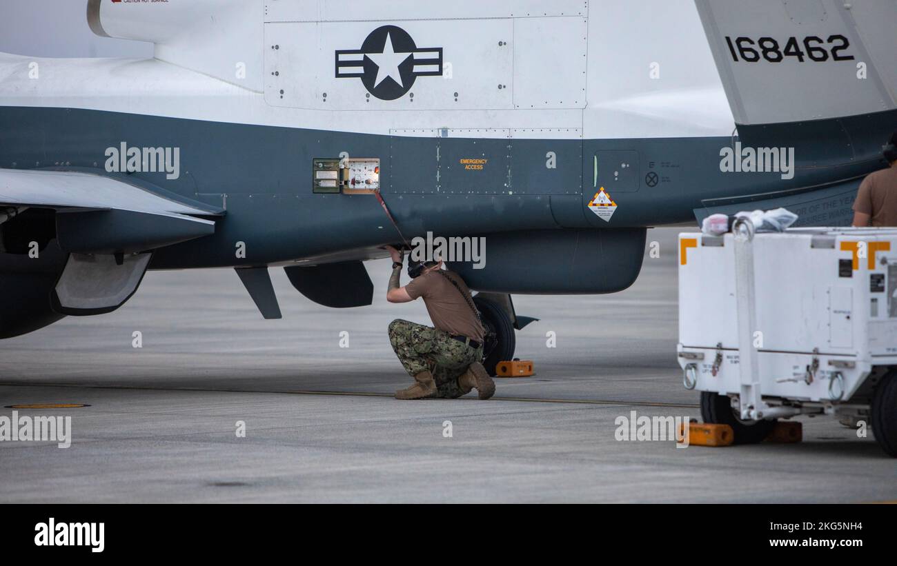 U.S. Navy Sailors with Unmanned Patrol Squadron 19 inspect a MQ-4C ...