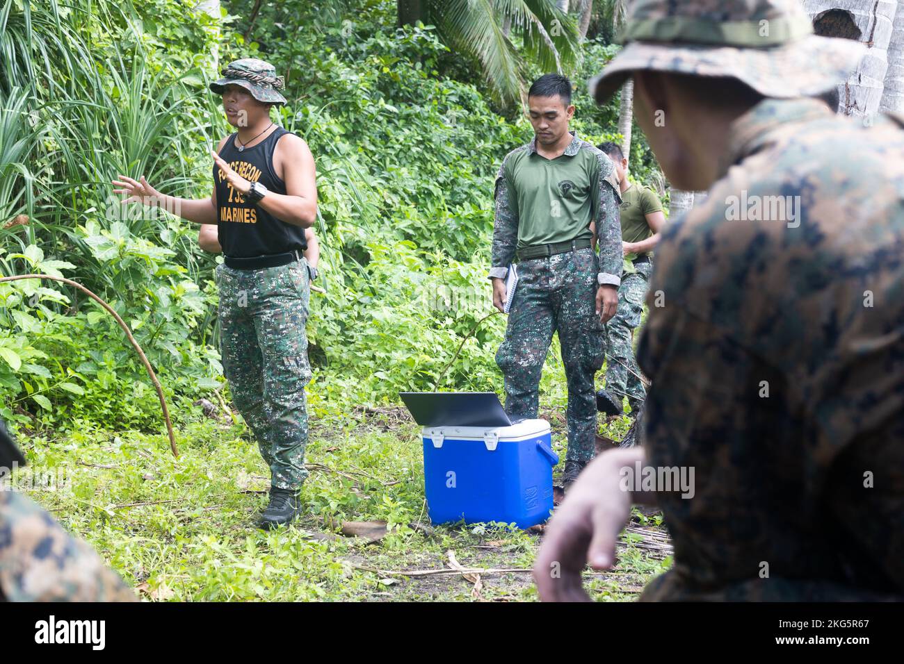 A Philippine reconnaissance Marine teaches U.S. Marines with the Maritime Raid Force, 31st ...