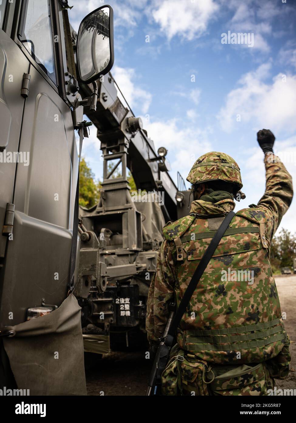 A soldier with the Japan Ground Self Defense Force guides a crane ...