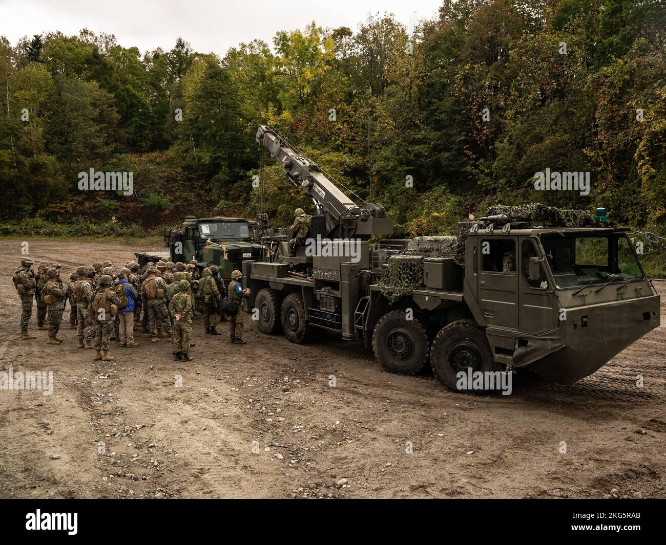 Soldiers with the Japan Ground Self Defense Force attach a tow bar to a ...