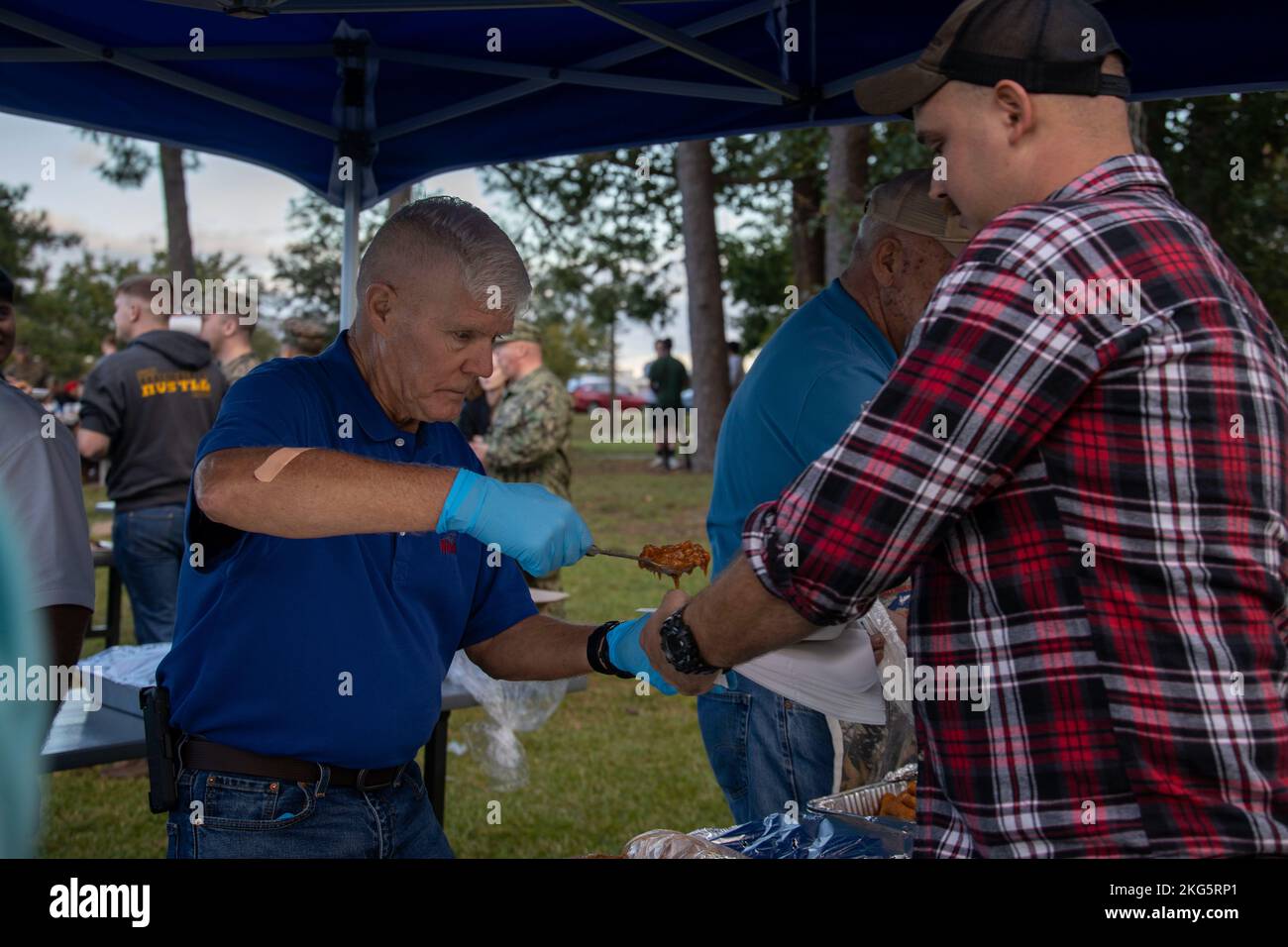 Retired U.S. Marine Corps Maj. Gen. Tom Braaten serves food to U.S ...