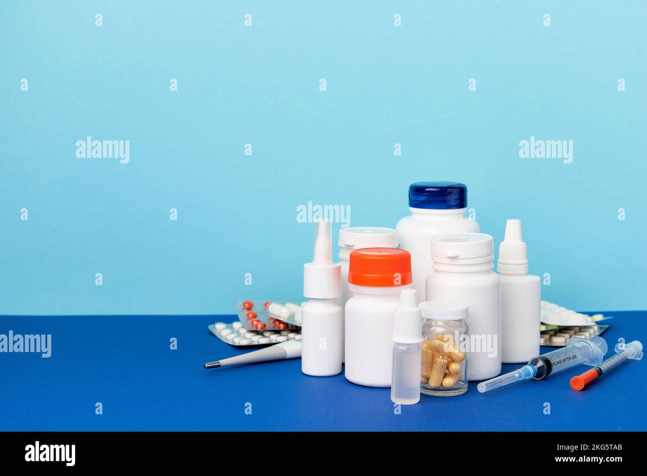 Different medicine pills on blue table. Healthcare pharmacy and ...