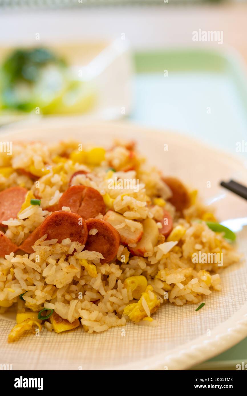 angle view fried rice with crab sticks and sausages and maizes vertical ...