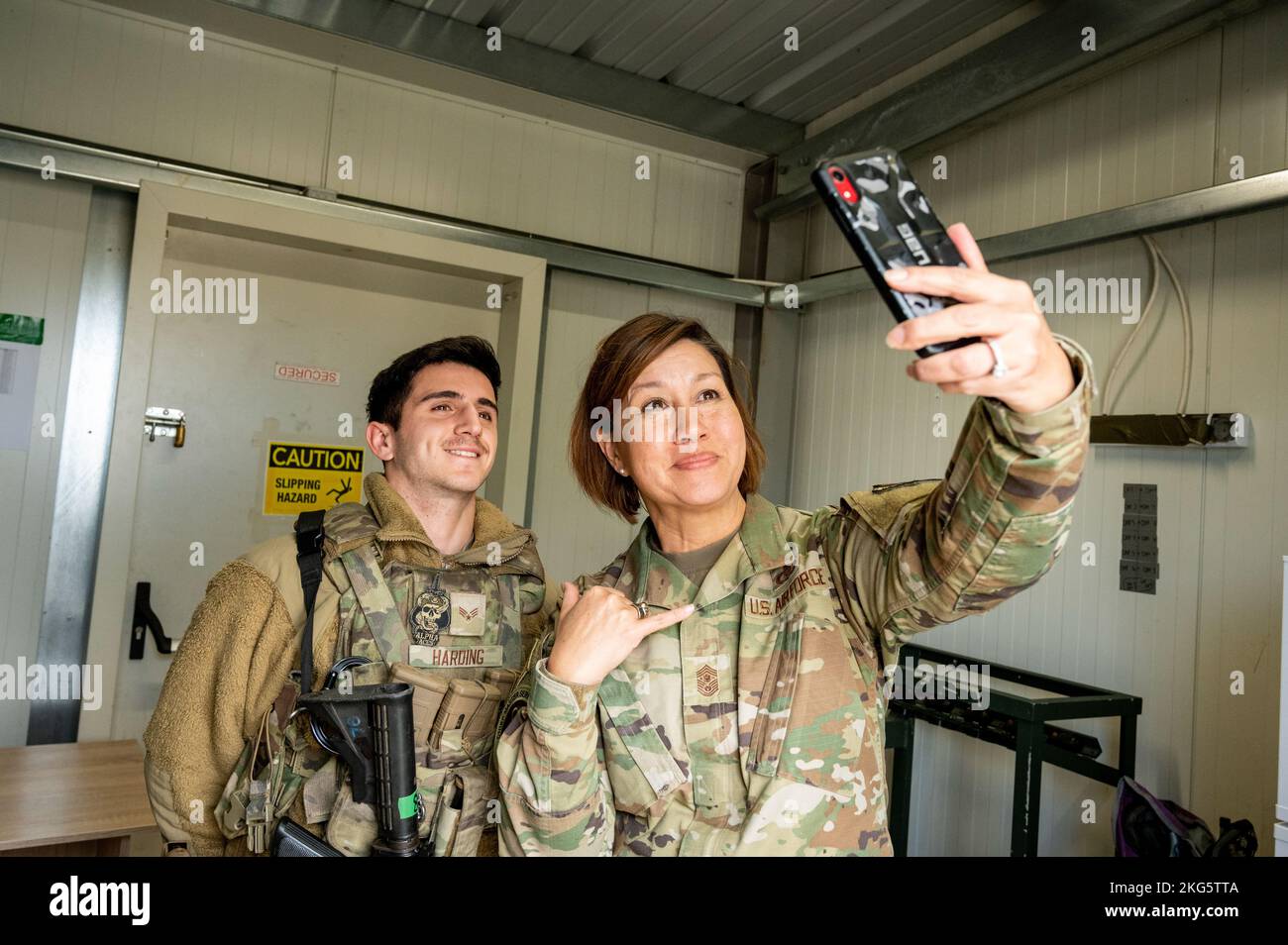Chief Master Sergeant of the Air Force JoAnne S. Bass take a photo with a deployed U.S. Air ...