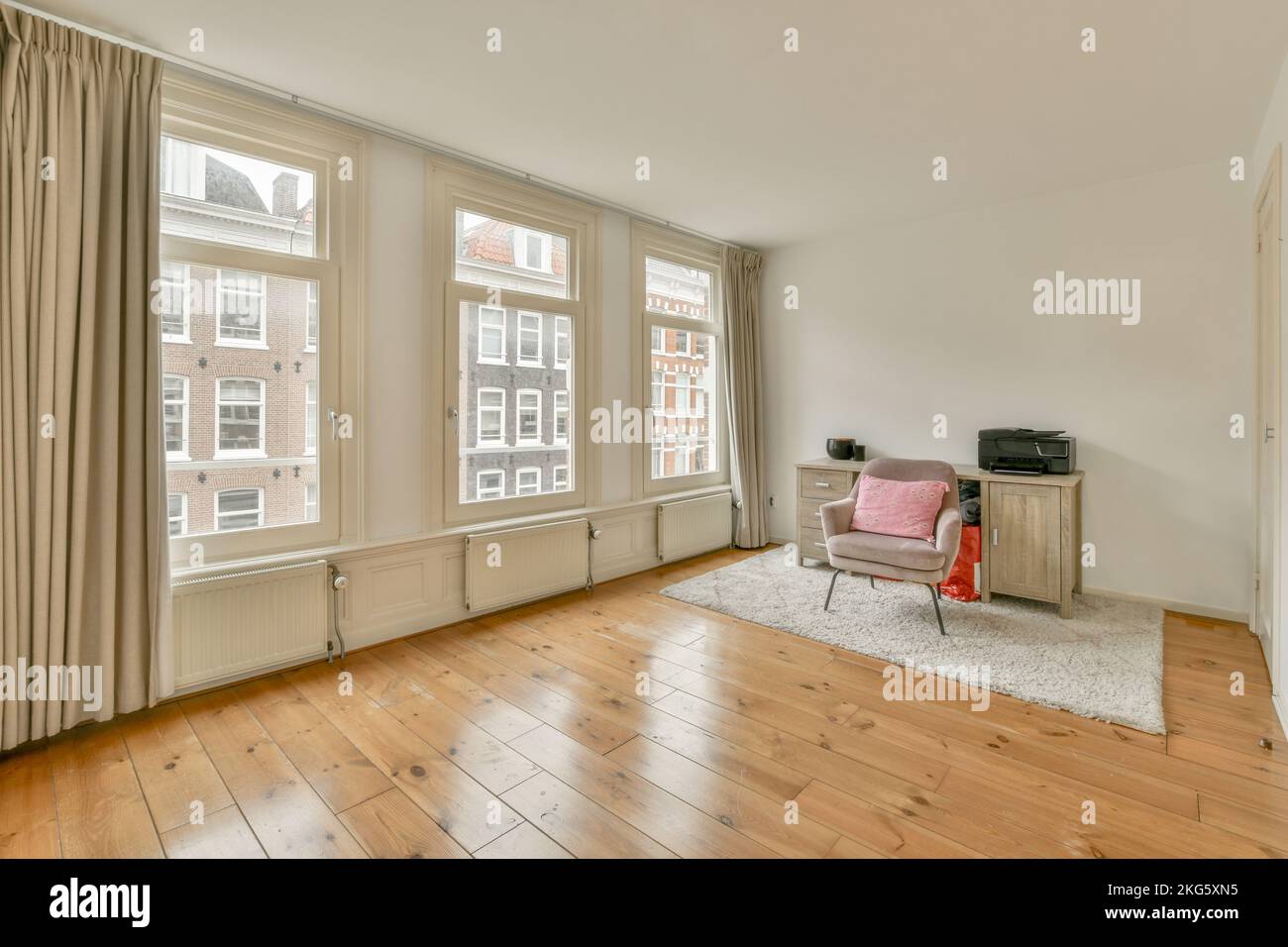 Interior of light home office with desk and printer near window with ...