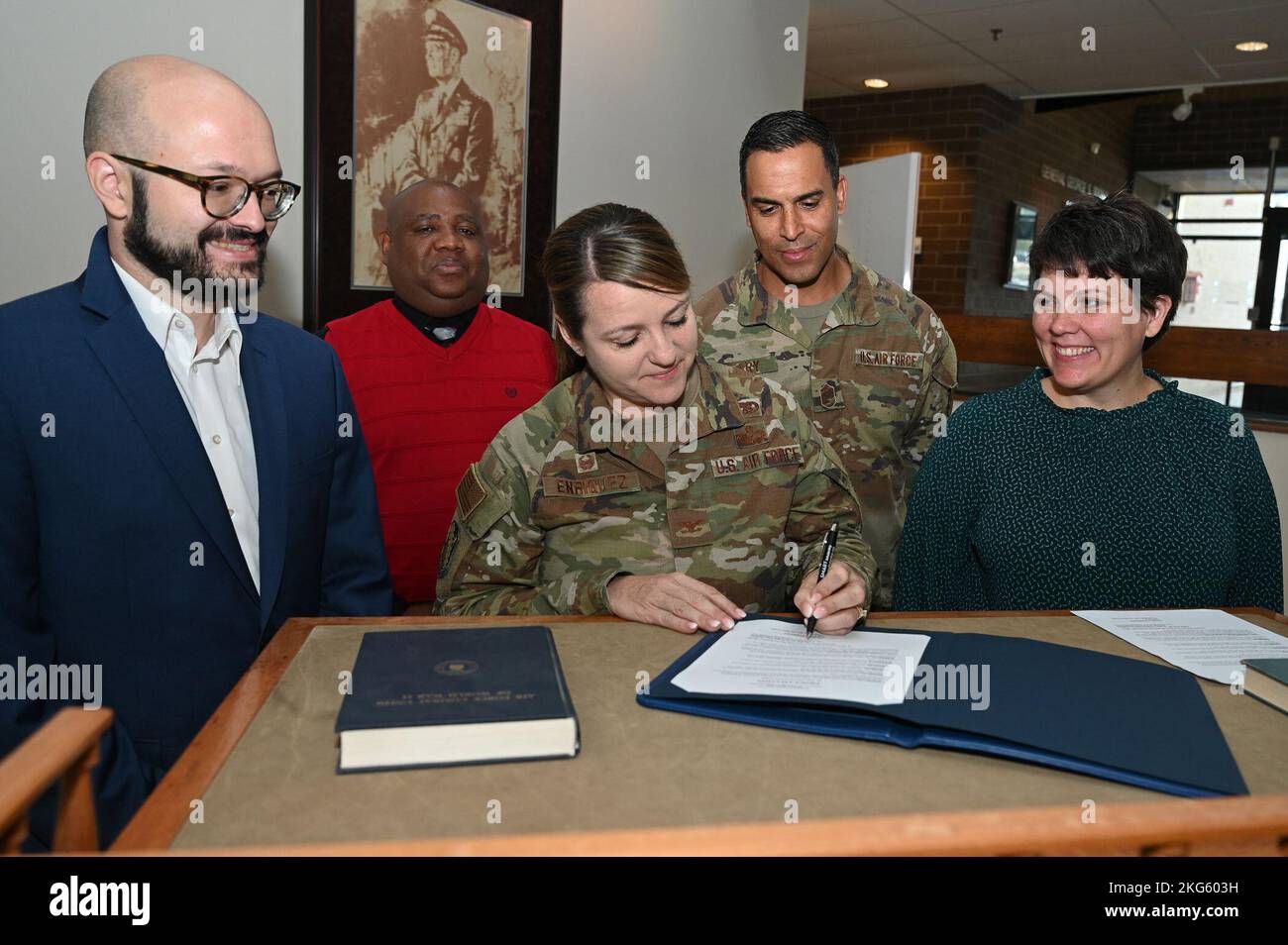 Col. Taona Enriquez, installation commander, signs a National ...