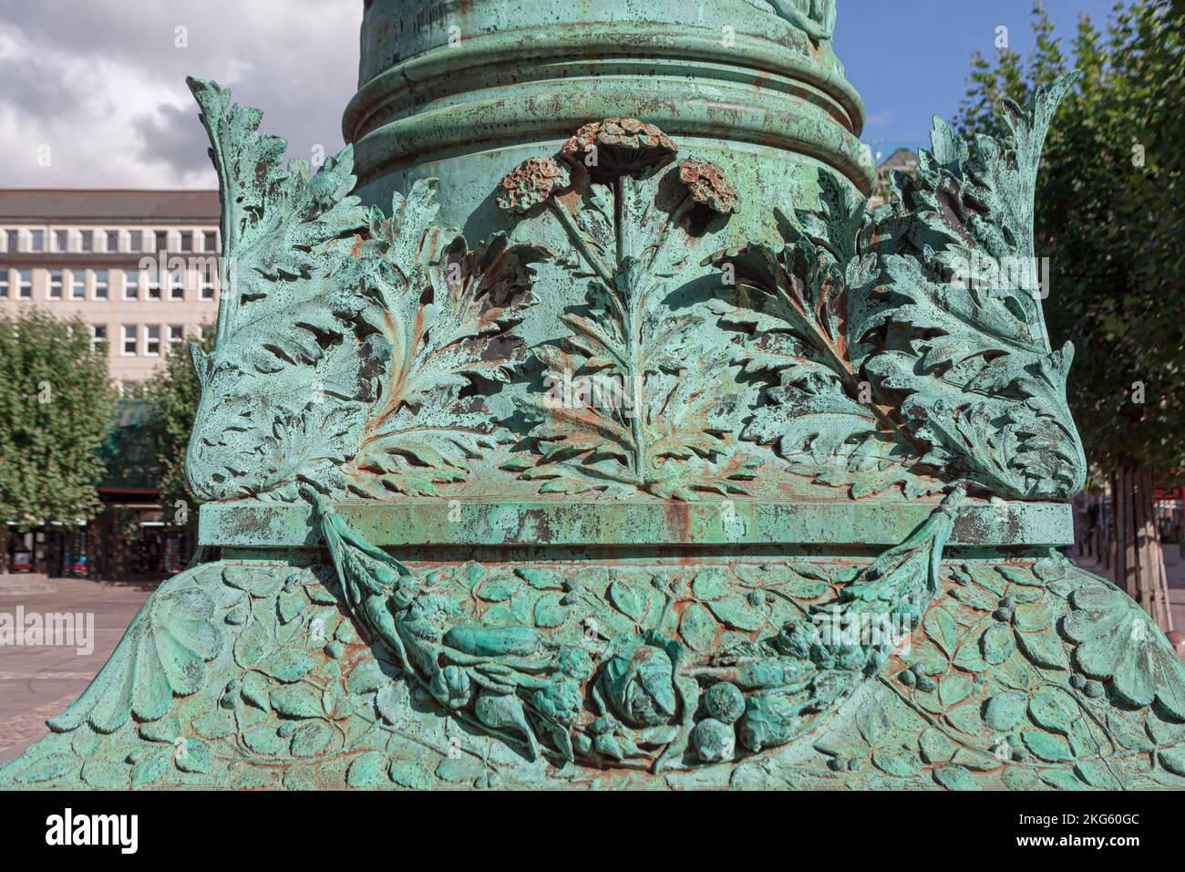 Flowers carved in iron . Bronze base of column Stock Photo - Alamy