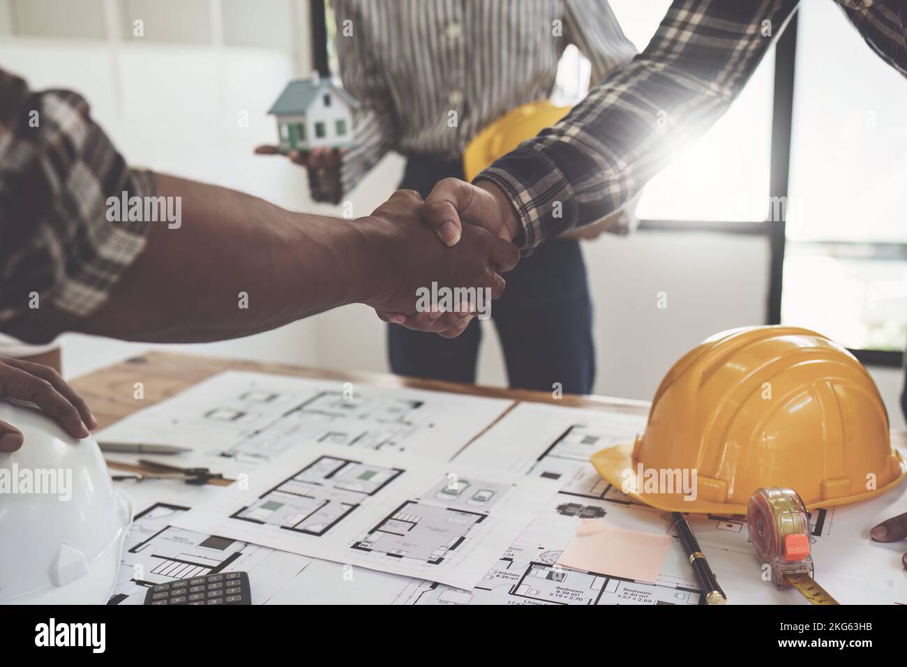Architect and engineer construction workers shaking hands after finish ...