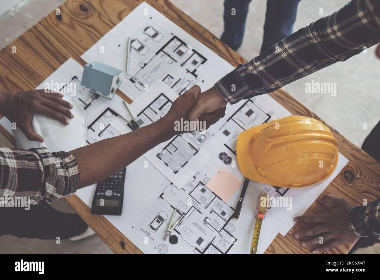 Architect and engineer construction workers shaking hands after finish ...