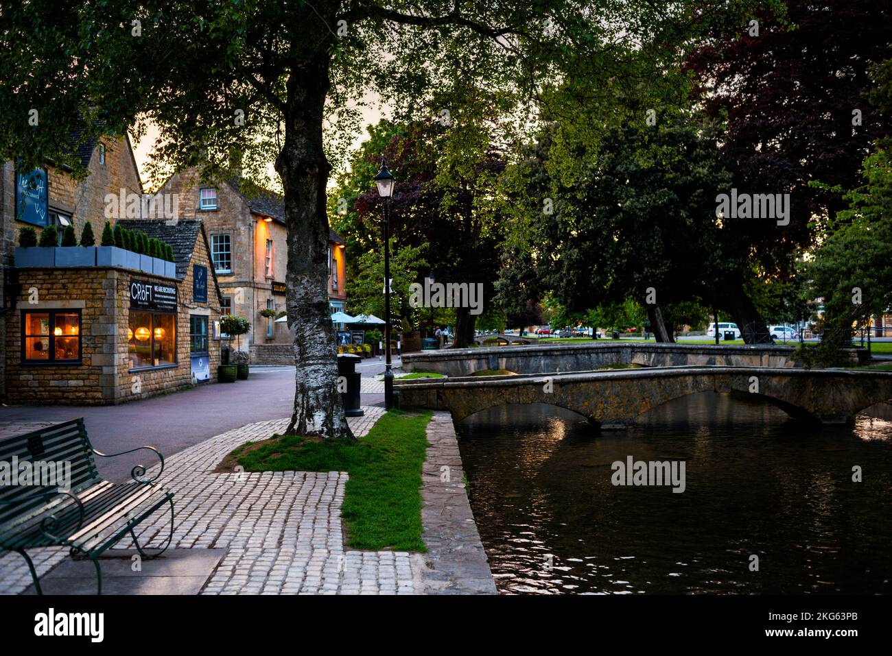 Storybook architecture, arched stone footbridges and the River Windrush ...
