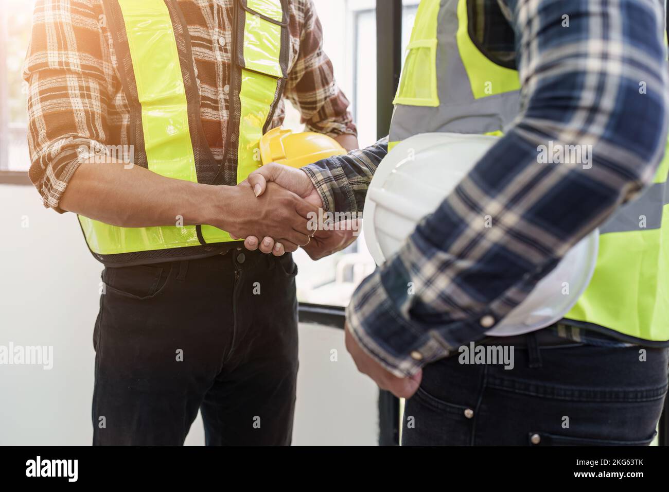 Architect and engineer construction workers shaking hands after finish an agreement in the ...