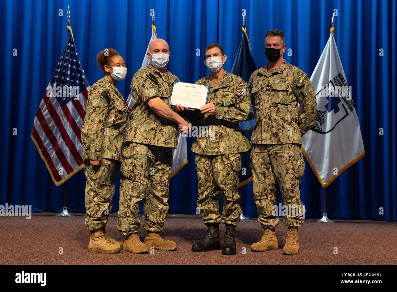 Capt. Christopher Reed, center right, poses for a group photo with Navy ...