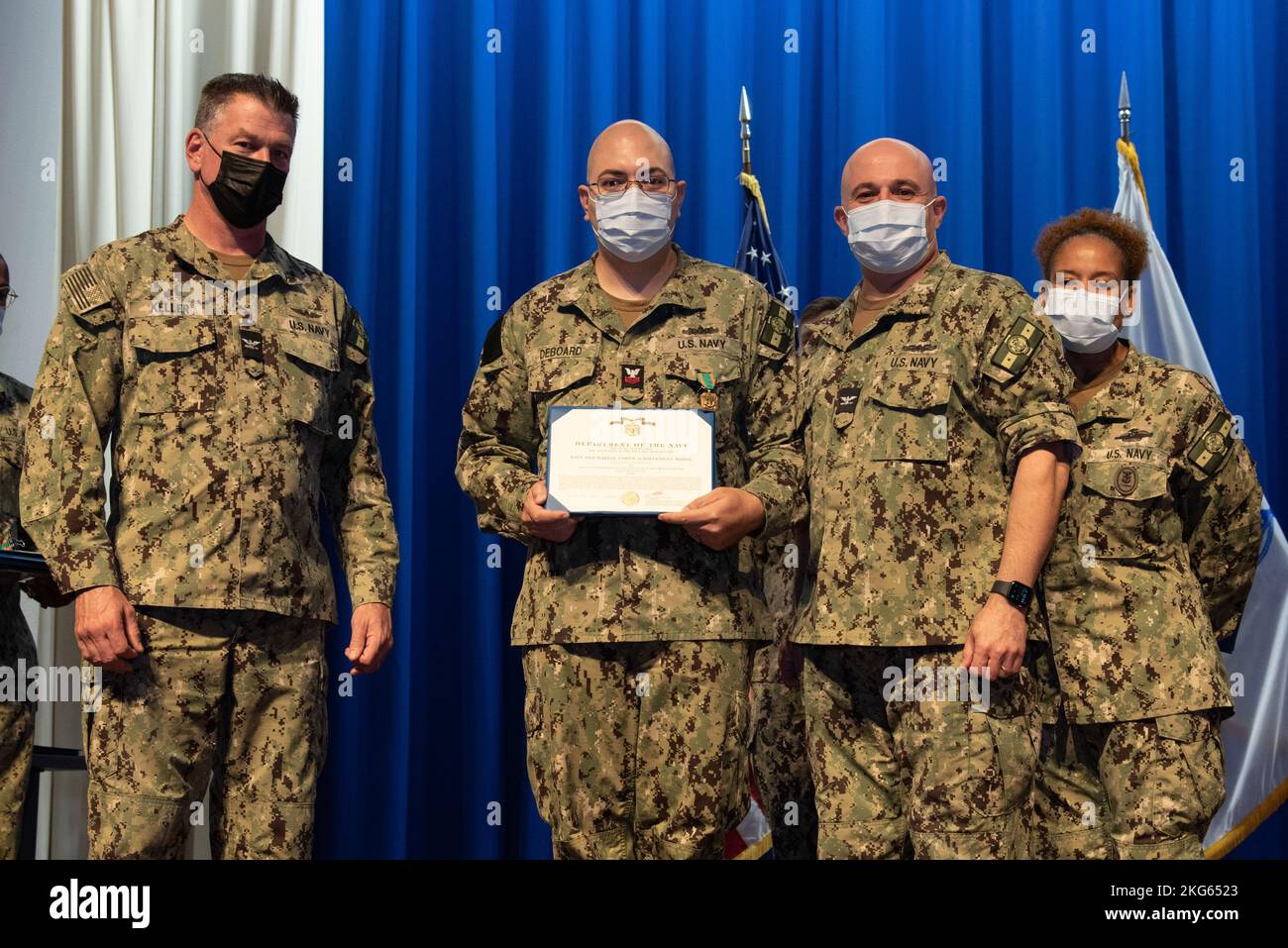 Hospital Corpsman 1st Class Drew Deboard, center left, poses for a ...