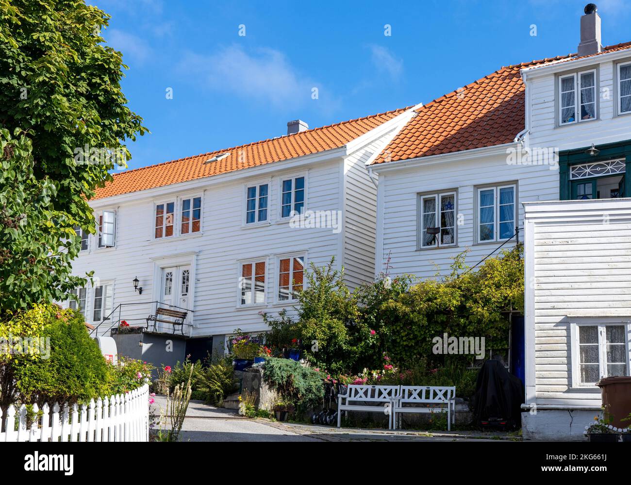 The exterior of a residential building with greenery, blue sky and ...