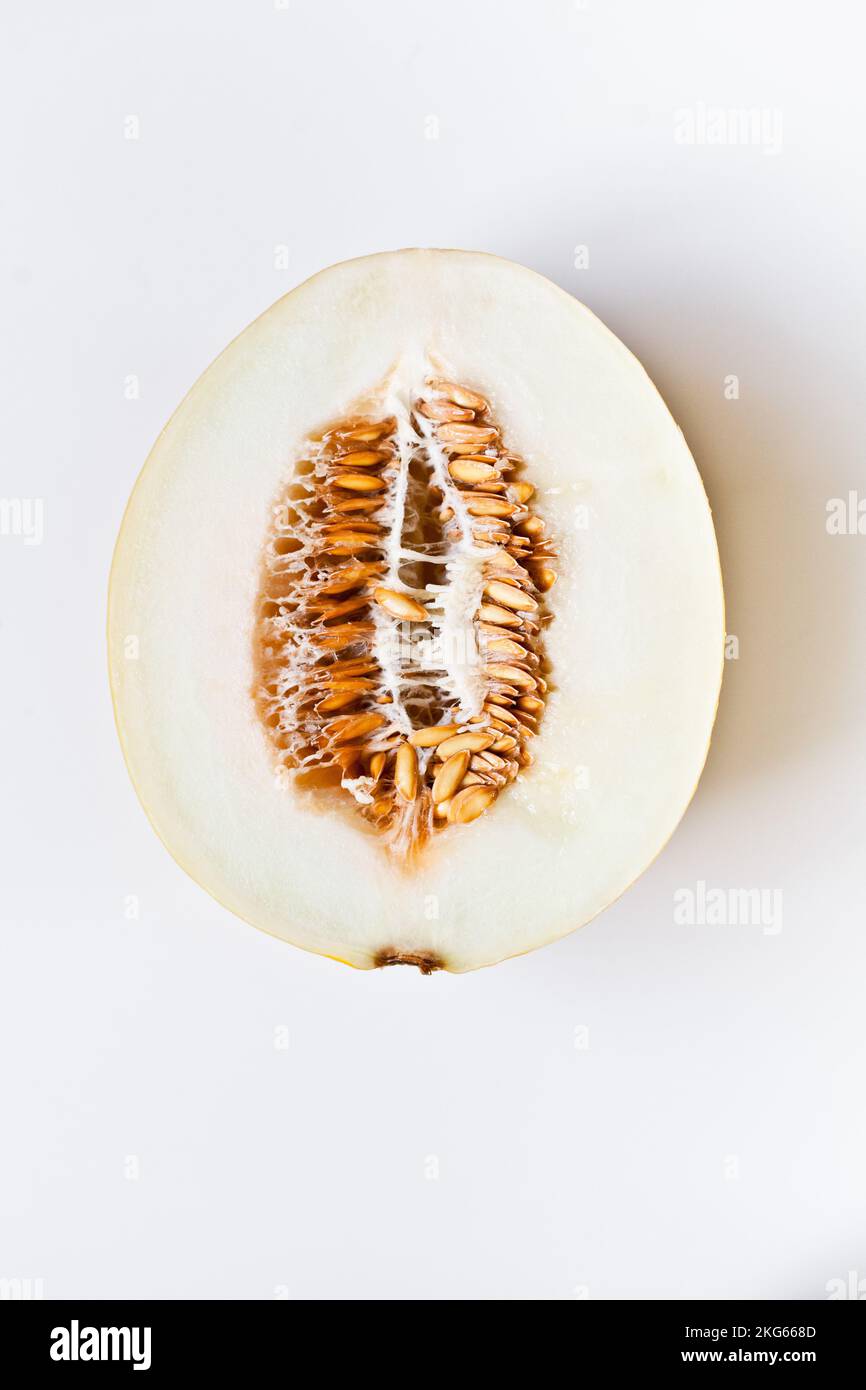 A vertical shot of a summer melon half isolated on white background ...