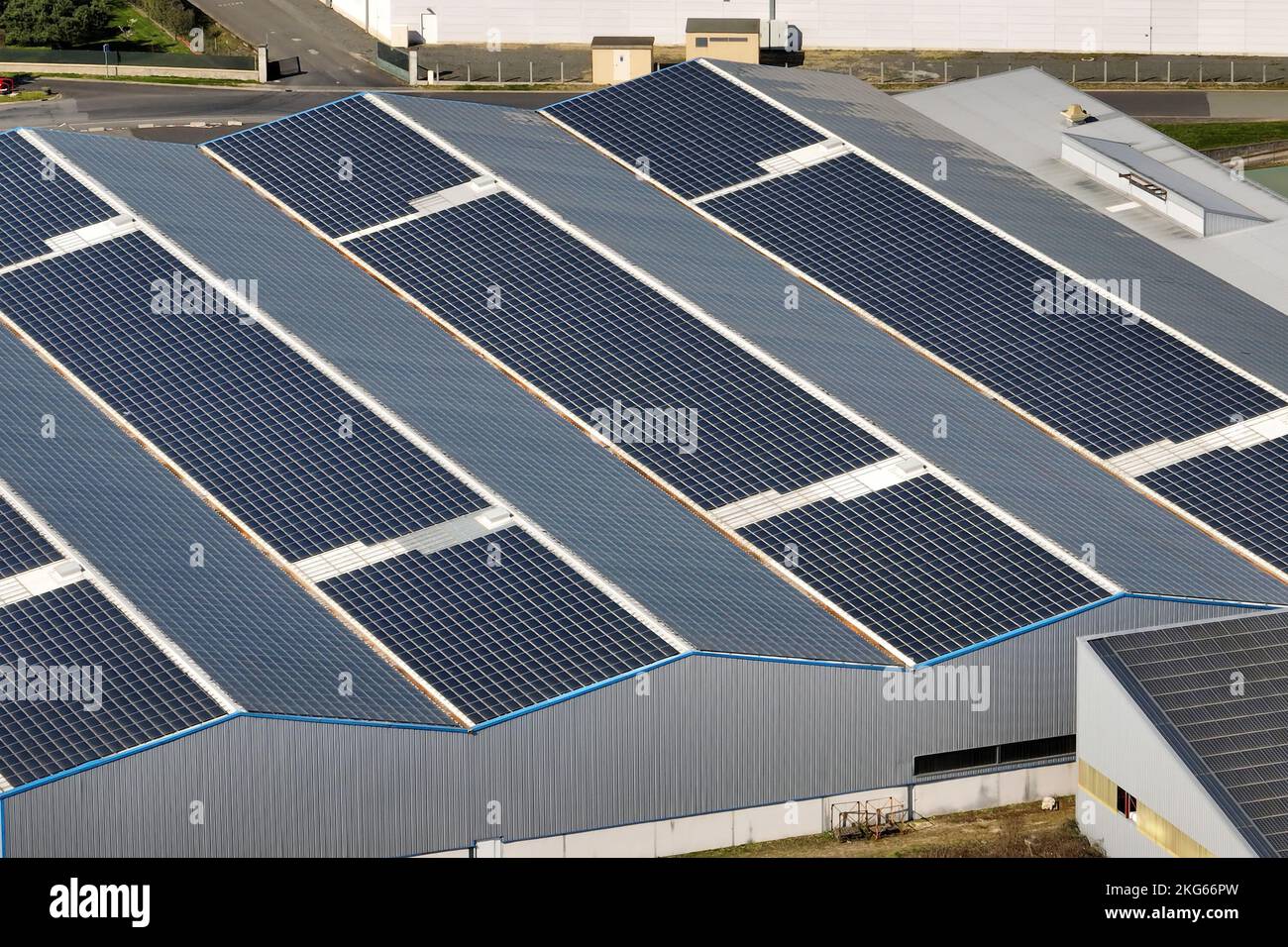 Aerial view of blue photovoltaic solar panels mounted on industrial ...
