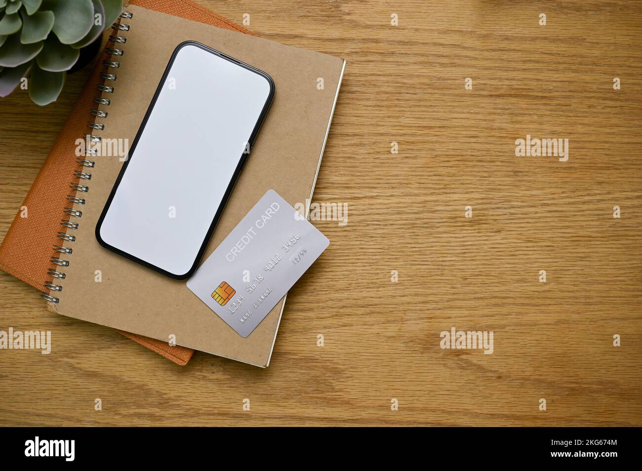 Workspace tabletop with smartphone white screen mockup, credit card ...