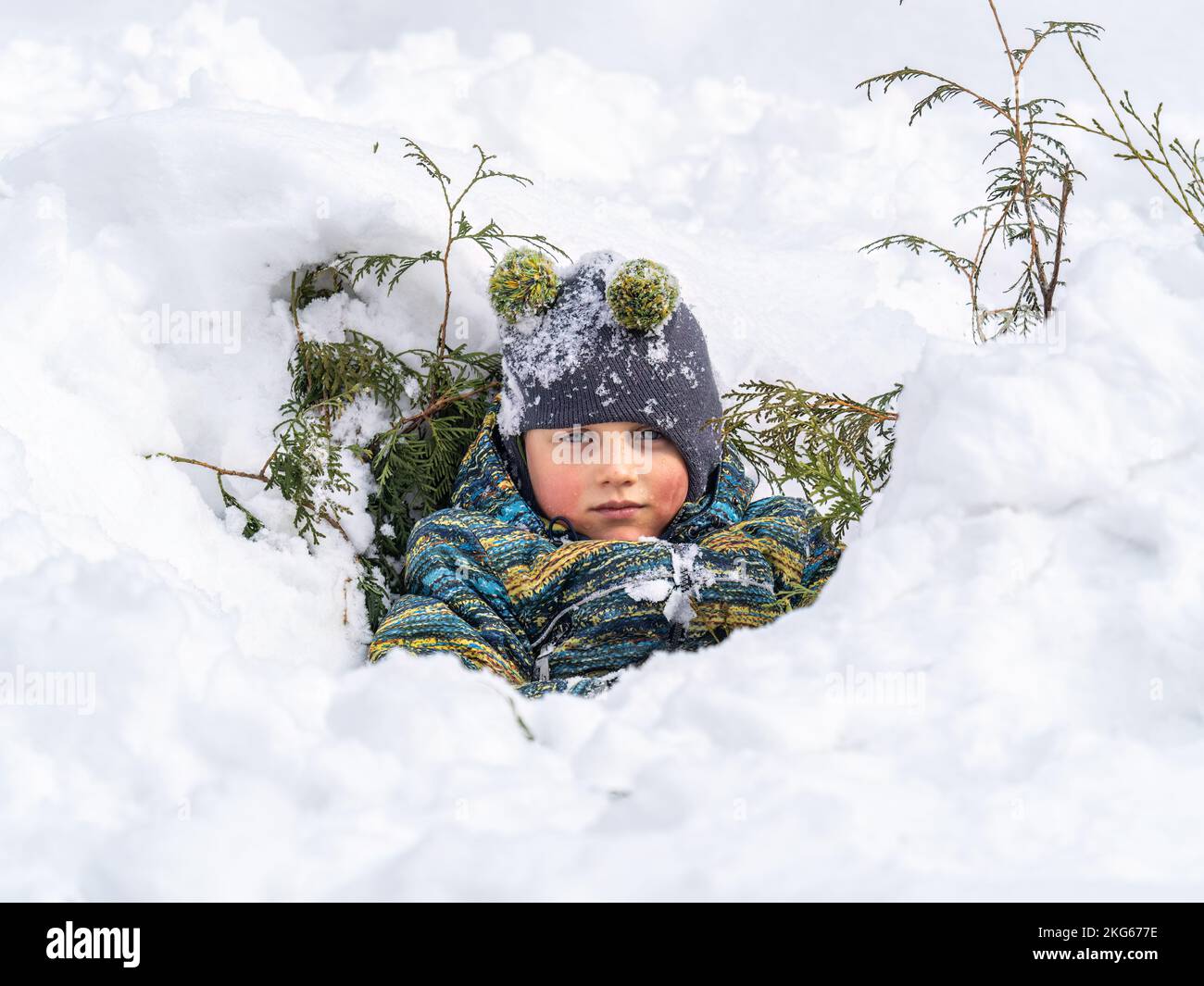 Happy baby boy playing in the snow. Little boy having fun in the snow ...