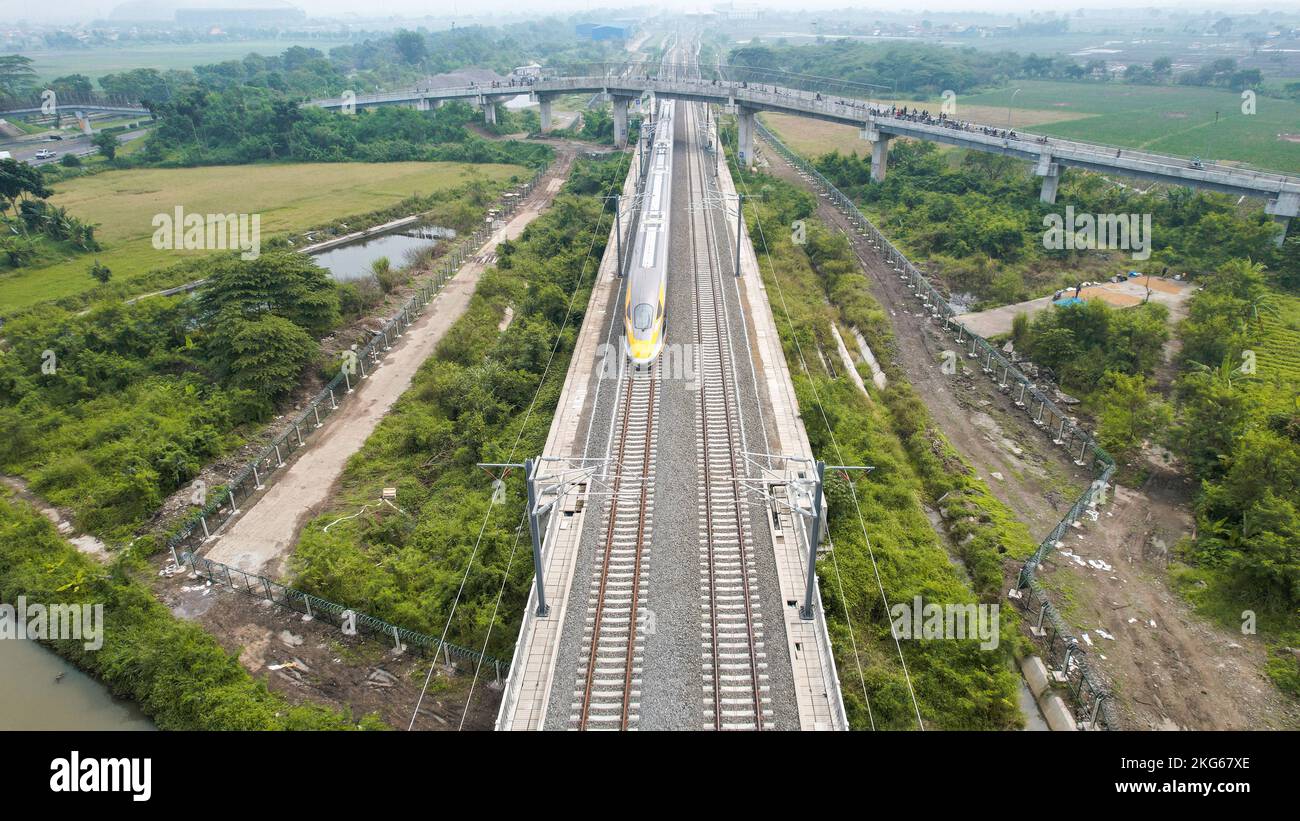 Aerial view of the High speed orange train on the railway station. High Speed Train Jakarta ...