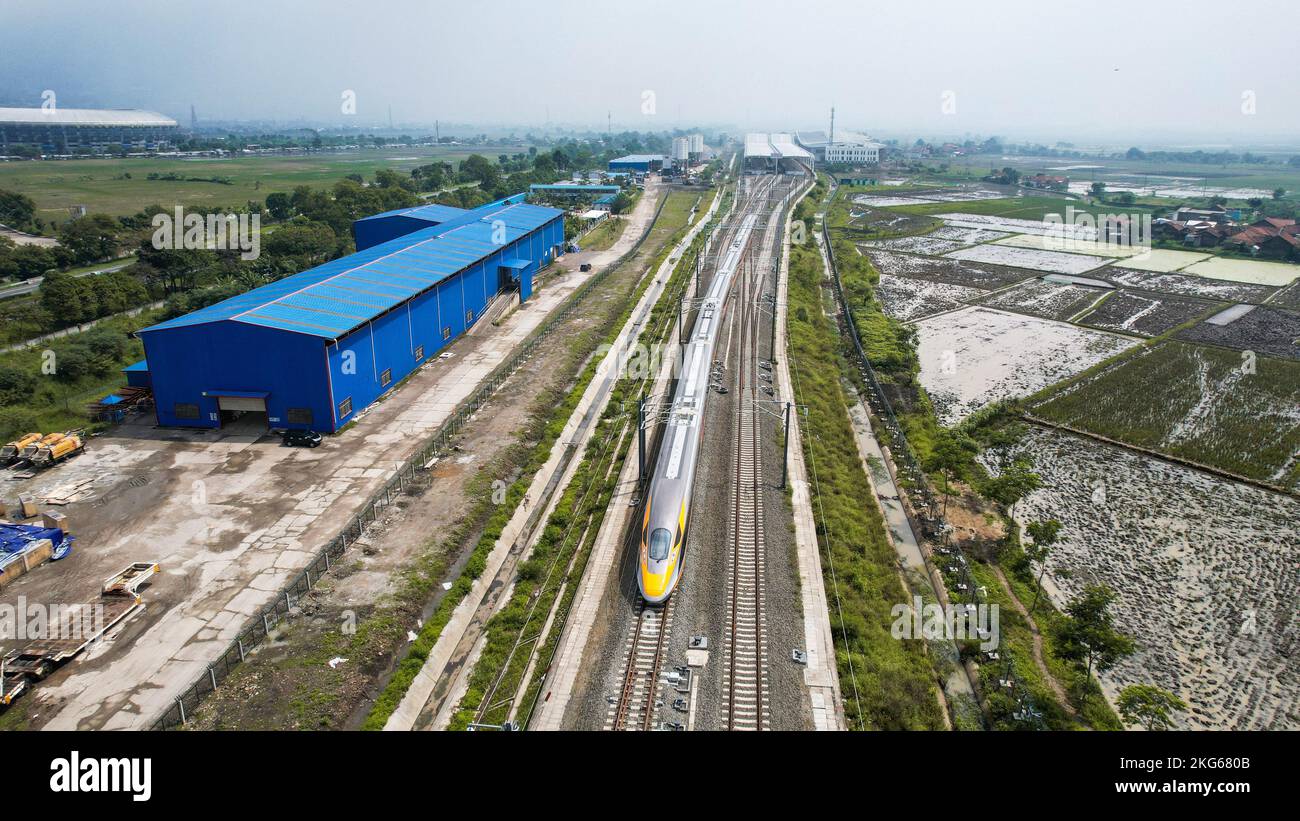 Aerial view of the High speed orange train on the railway station. High Speed Train Jakarta ...