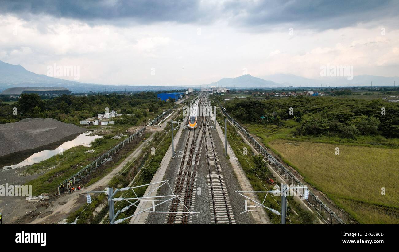 Aerial view of the High speed orange train on the railway station. High Speed Train Jakarta ...