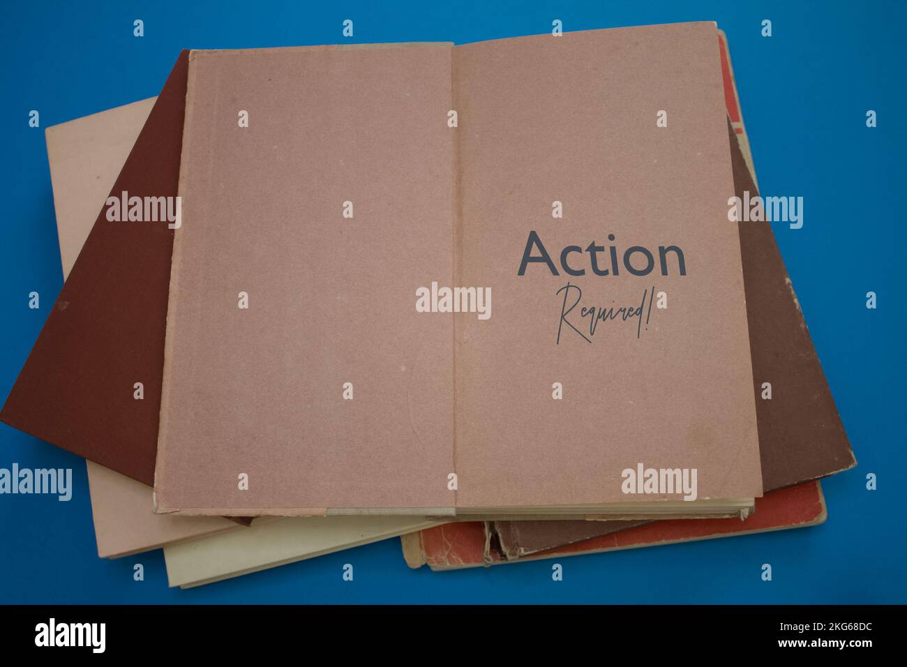 Action Required word in opened book with vintage, natural patterns old ...