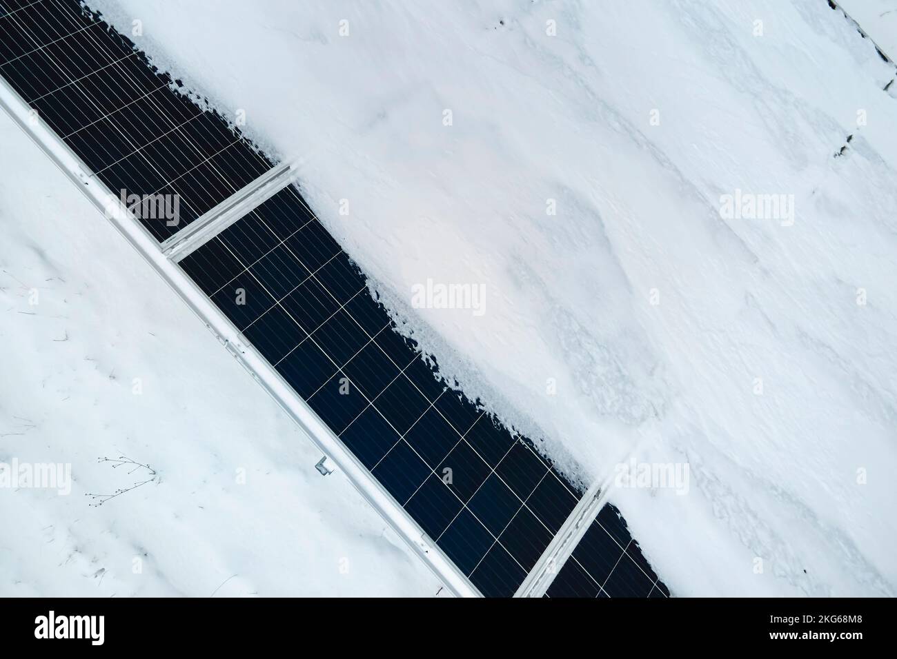 Aerial view of snow melting from covered solar photovoltaic panels at ...