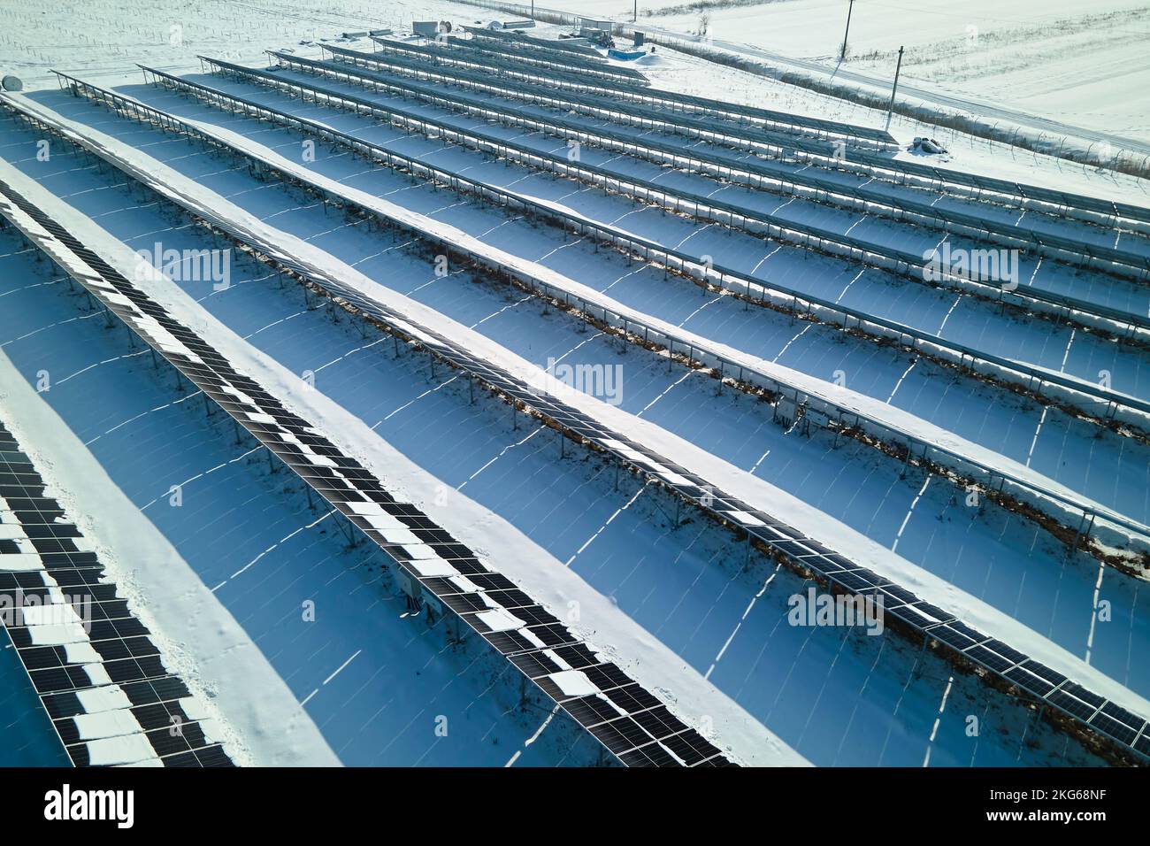Aerial view of snow melting from covered solar photovoltaic panels at ...