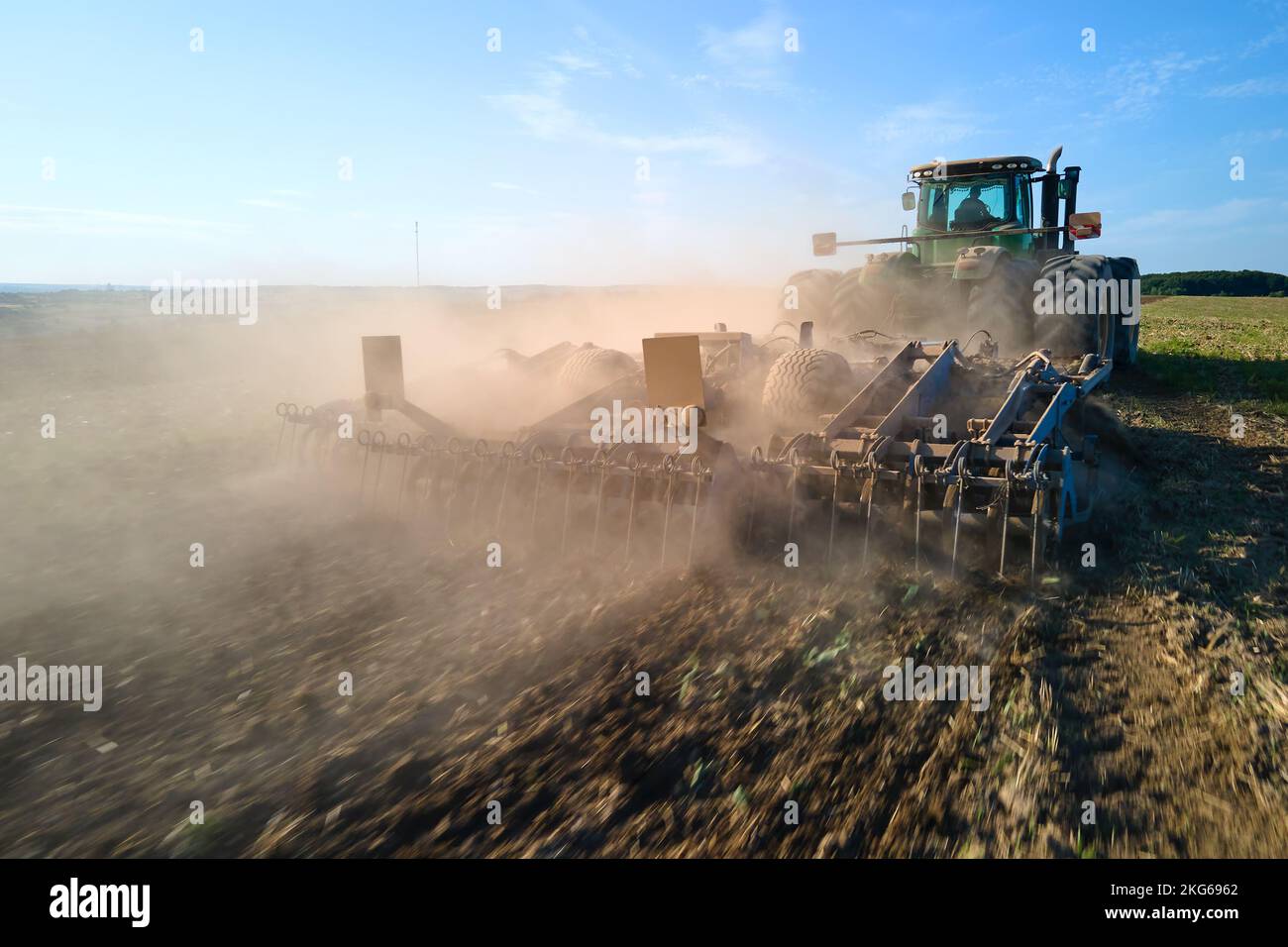 Aerial view of tractor plowing agriculural farm field preparing soil ...