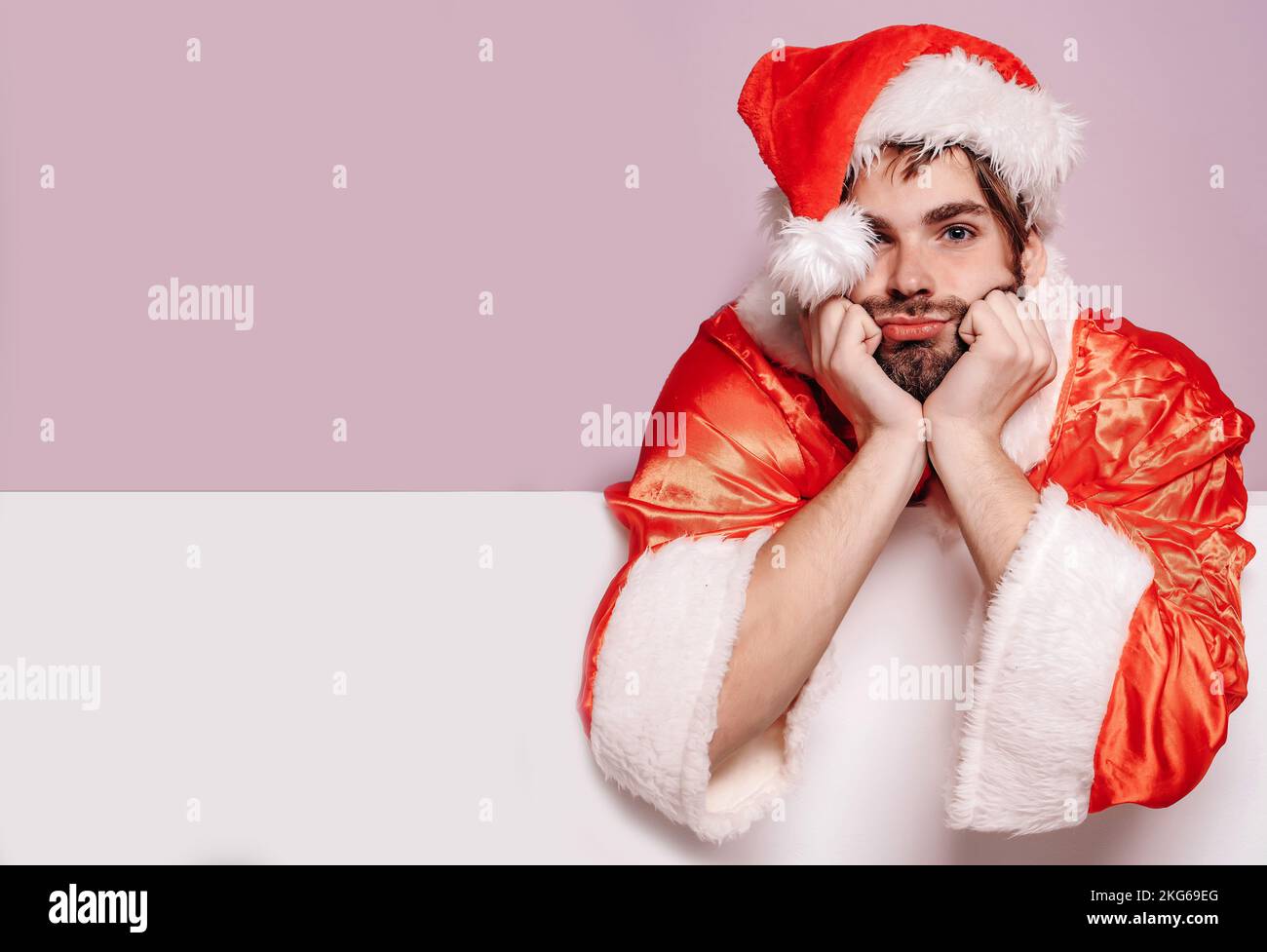 Funny sad man with christmas ball. Close up photo of guy isolated over ...